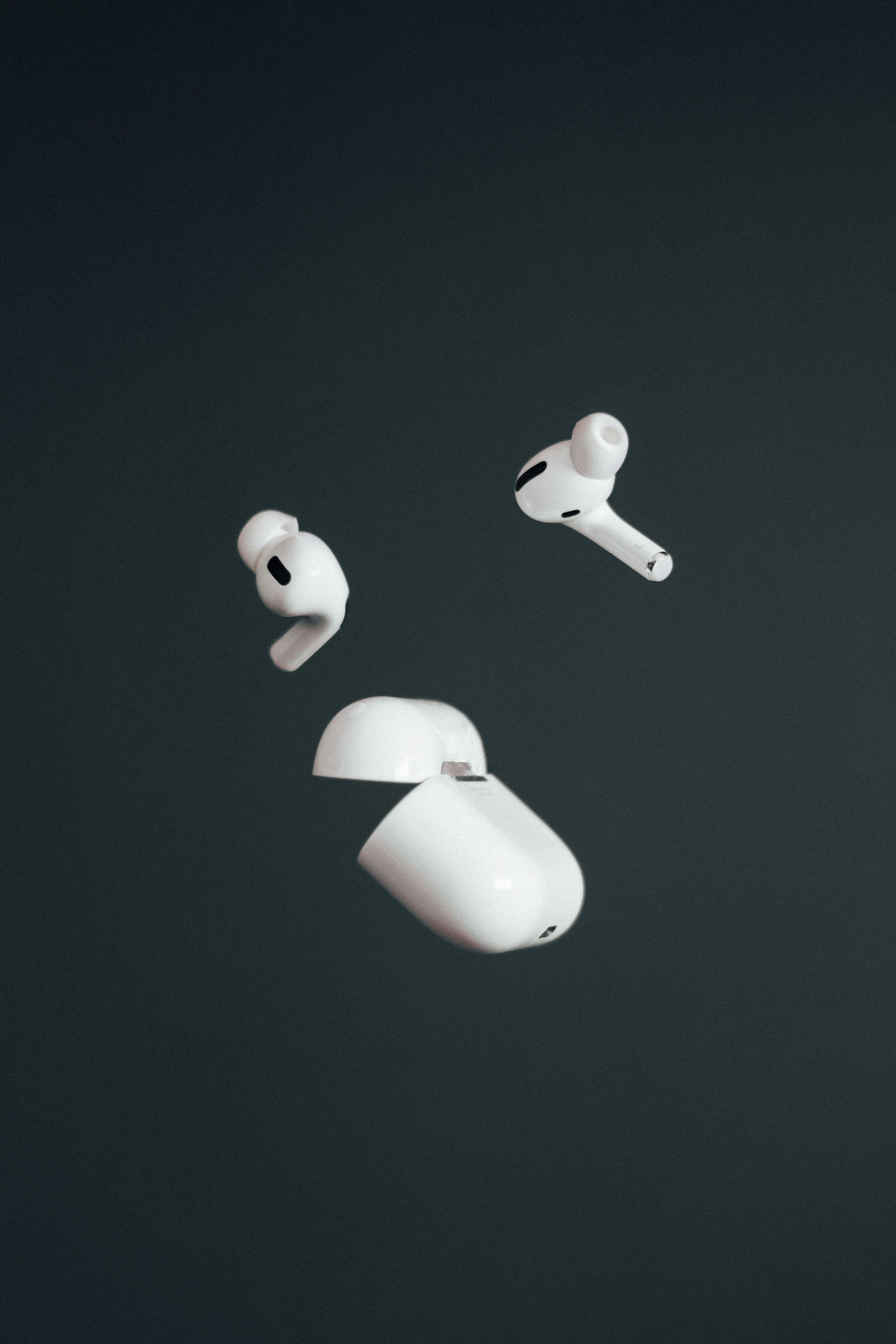 A pair of white ear buds floating in the air photo – Free Product ...