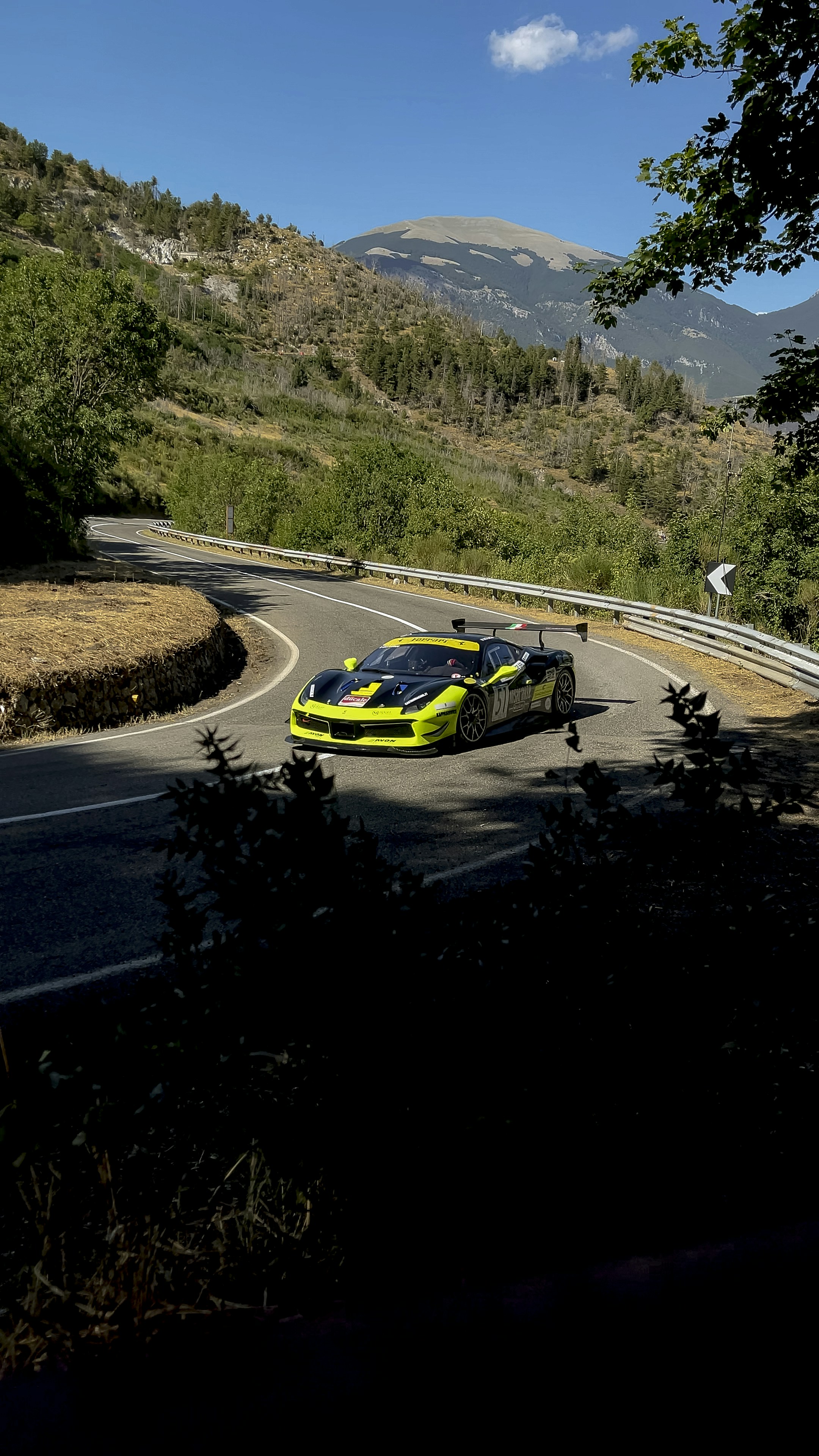 Neon-Yellow Race Car Conquers a Mountain Hairpin