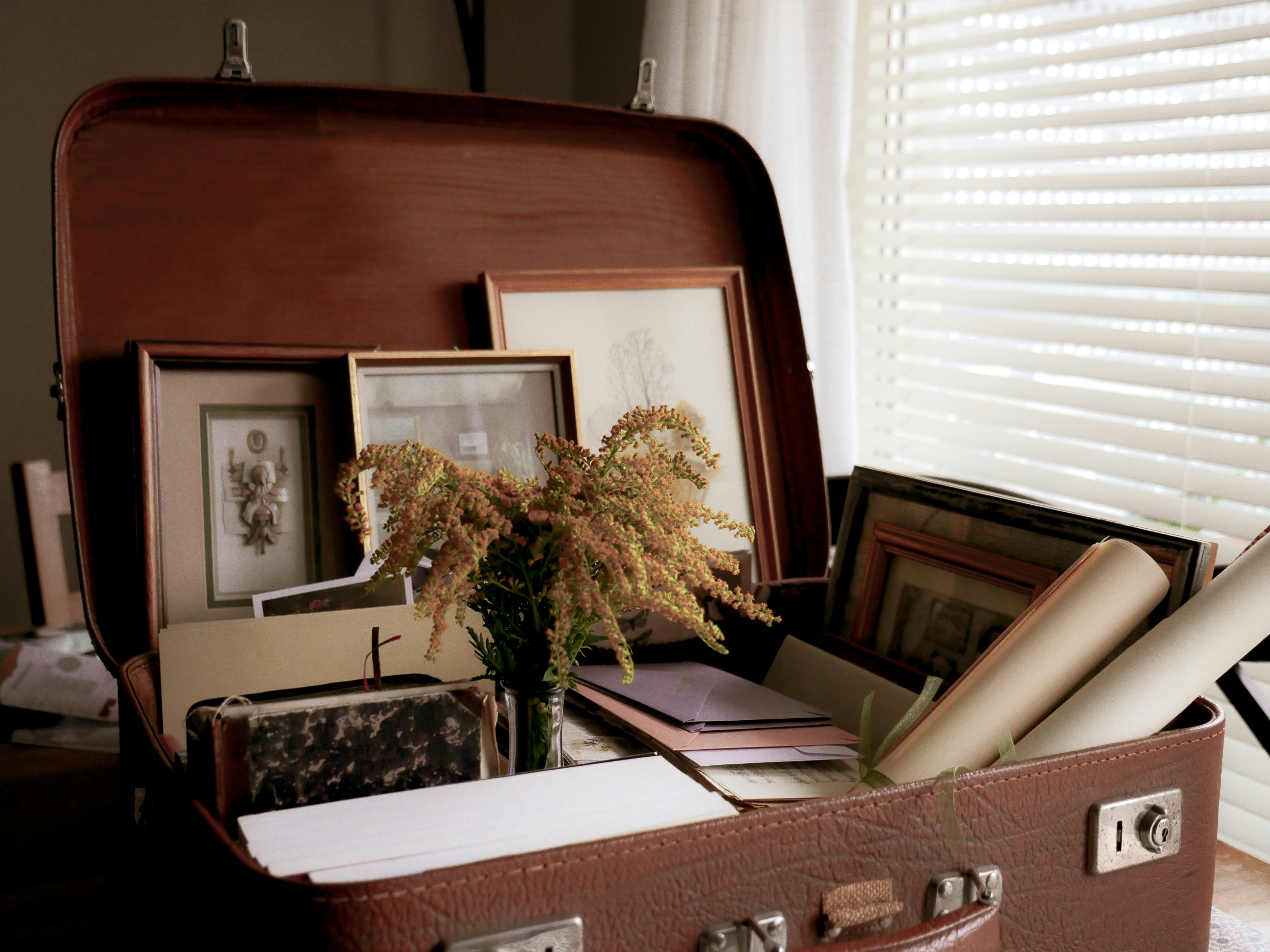 Open Suitcase of Keepsakes: A Quiet Still-Life of Memory and Paper