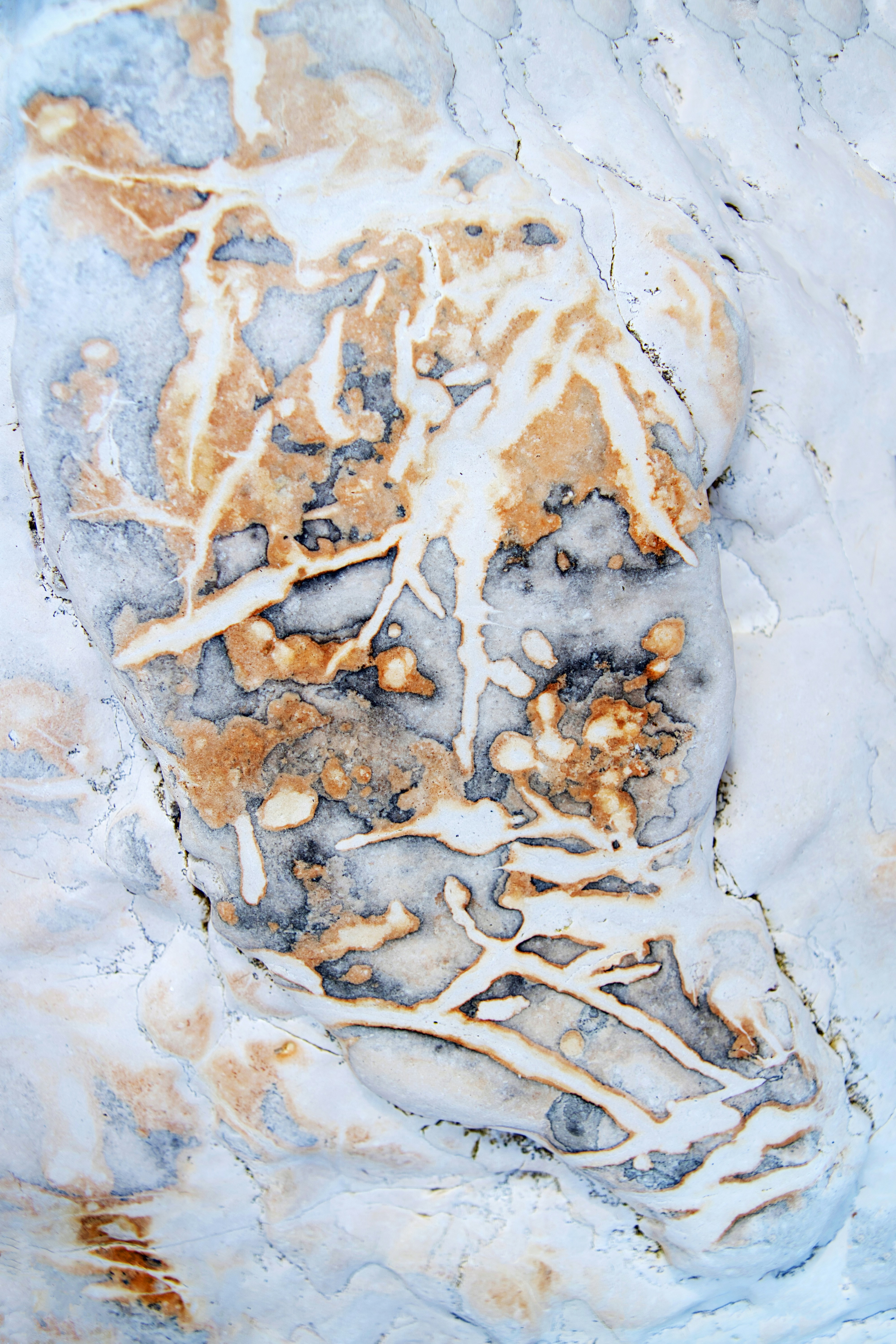 Rust Veins Woven Through Ice-Blue Stone