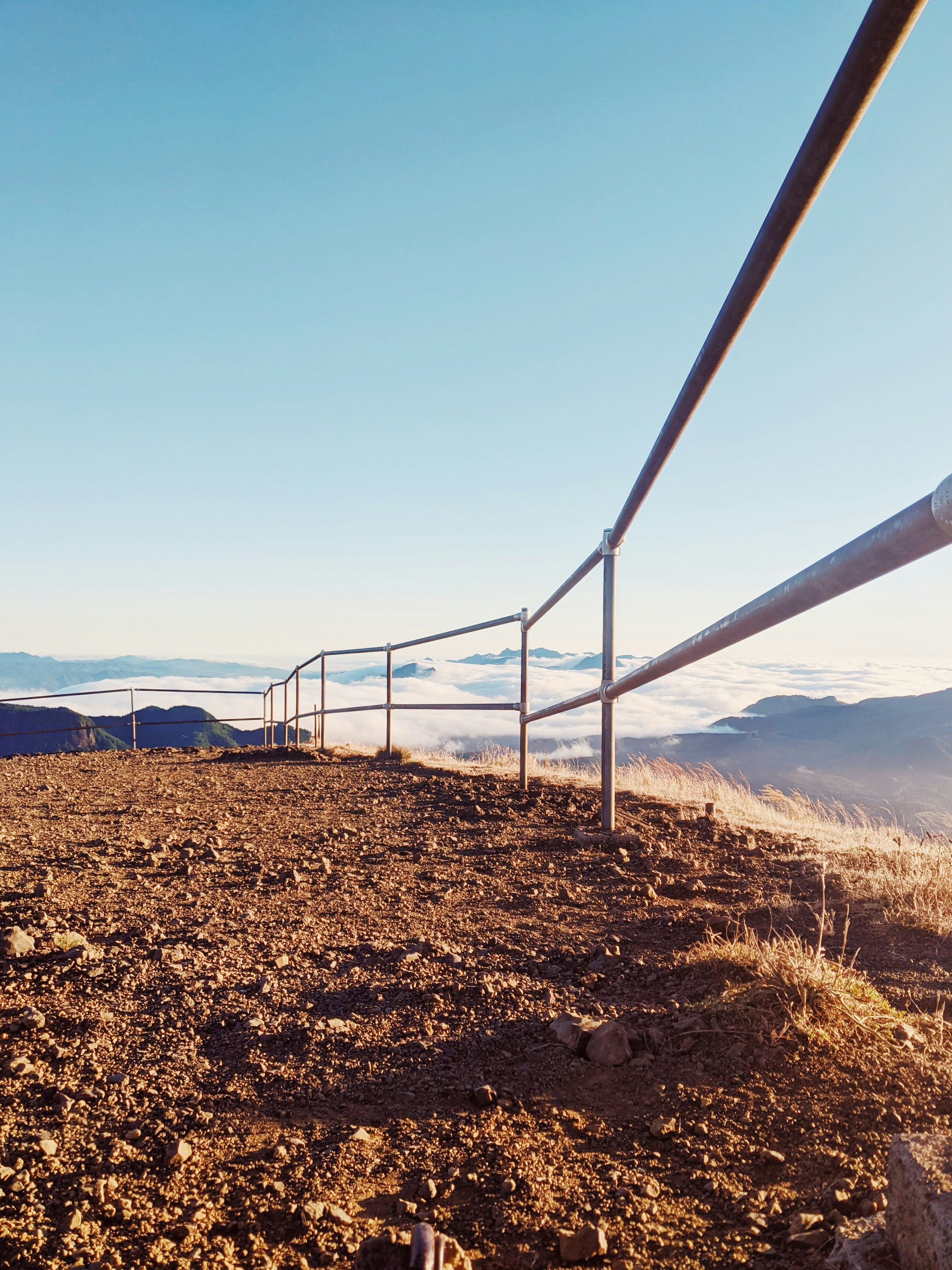 White metal railings on brown field during daytime photo – Free ...