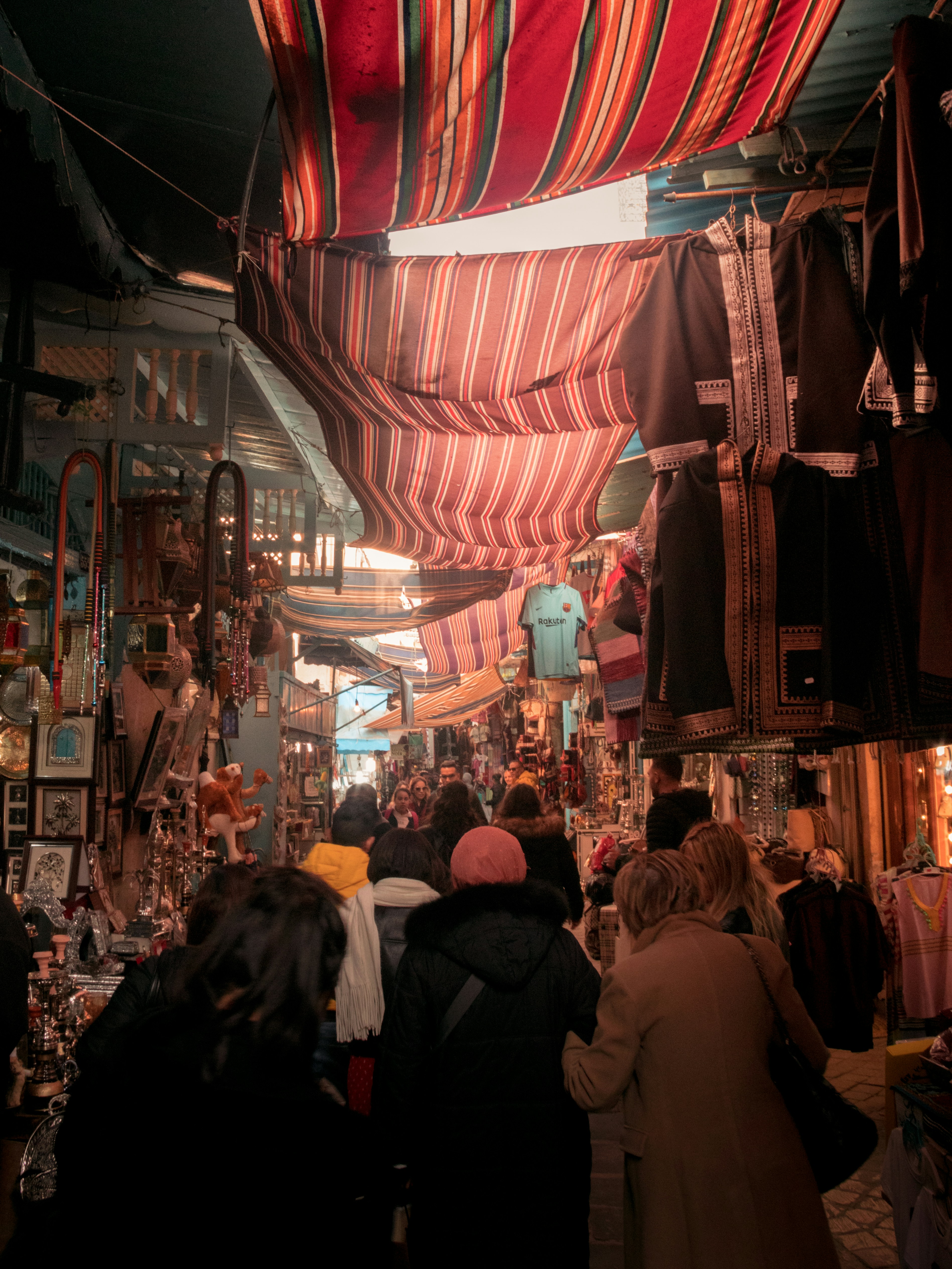A bustling marketplace filled with colorful textiles and unique artifacts, capturing the essence of local craftsmanship and community interaction.
