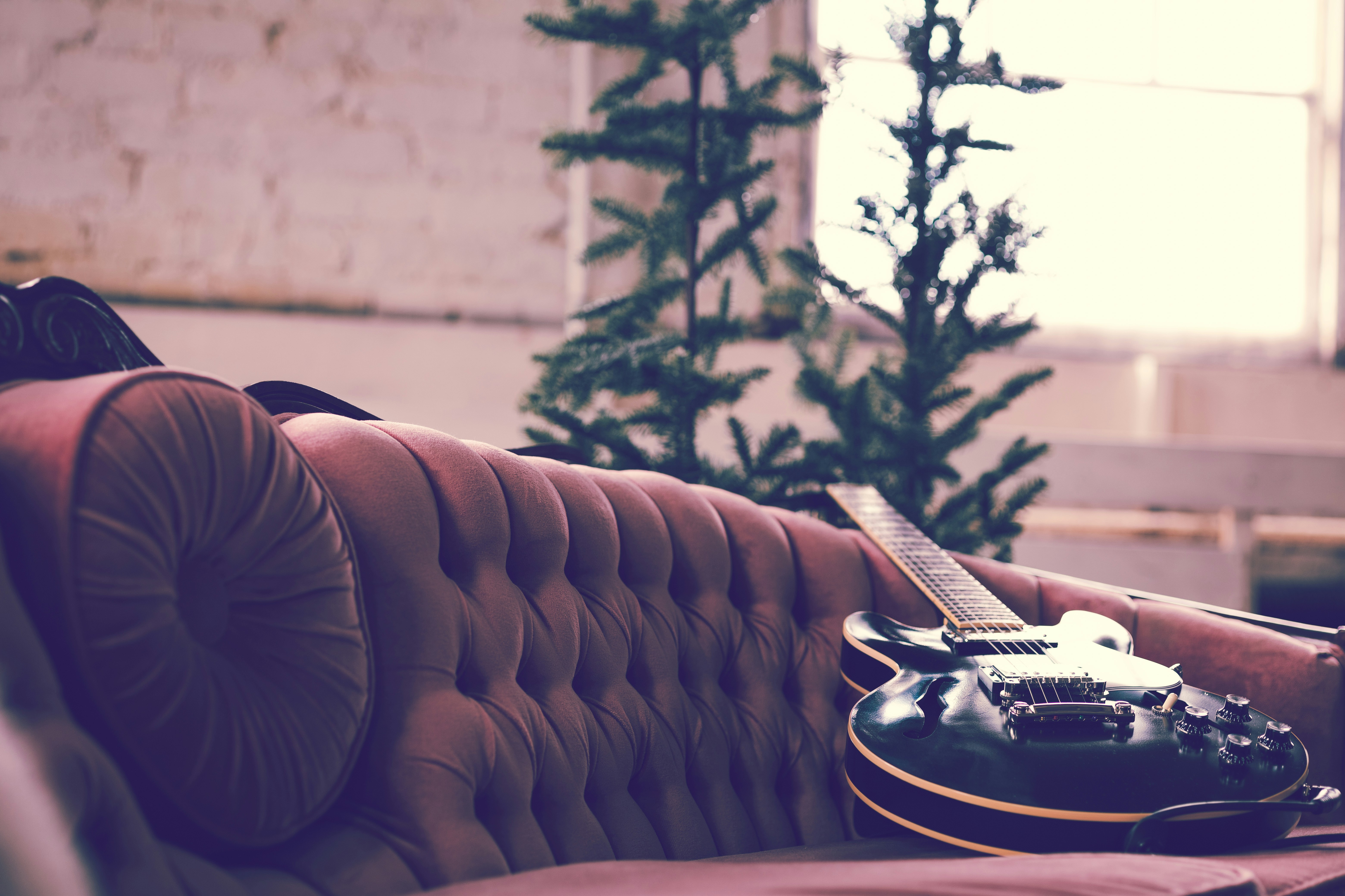 Sunlit Velvet and A Classic Guitar Resting on a Chesterfield