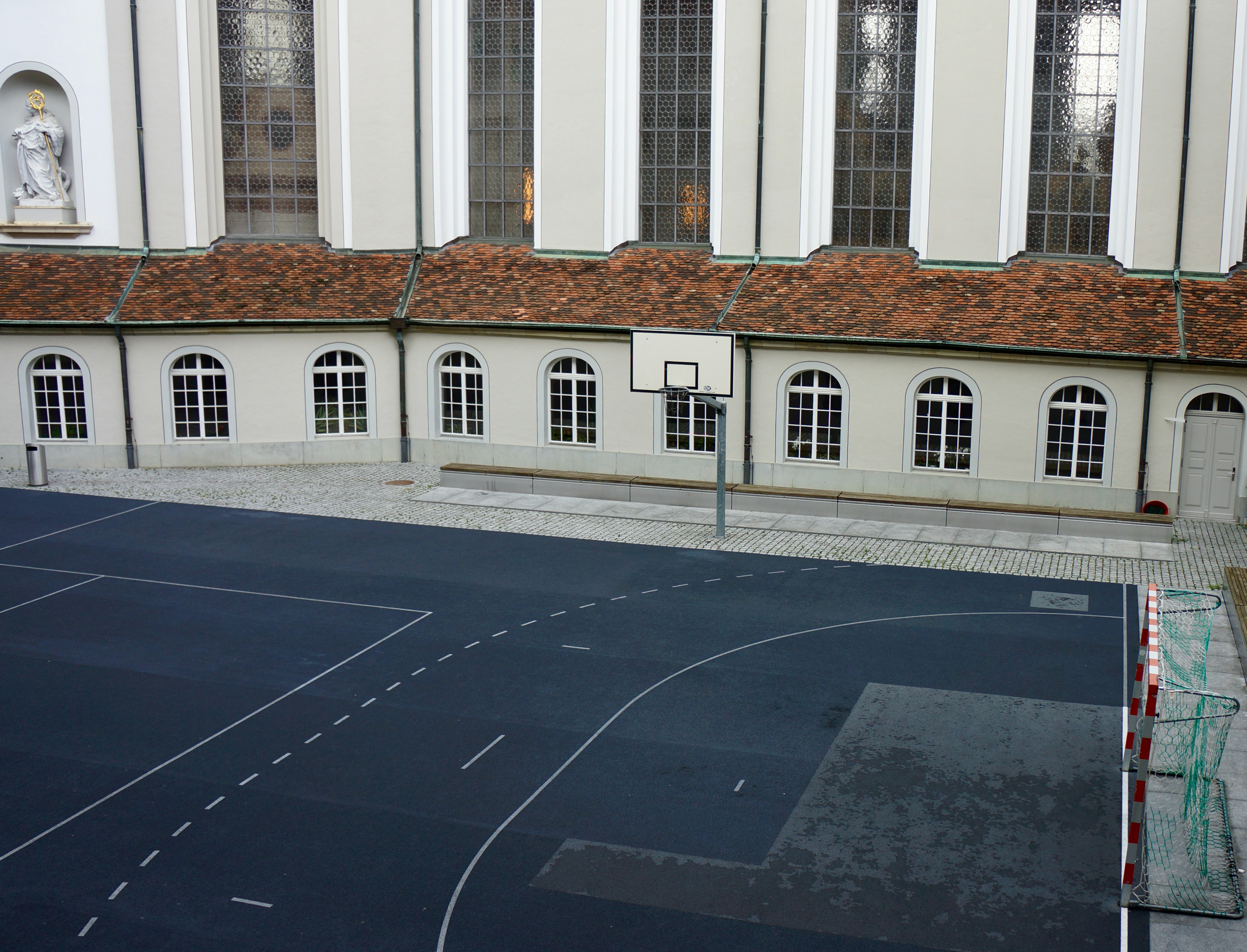 Basketball Hoop Overlooking a Classical Facade