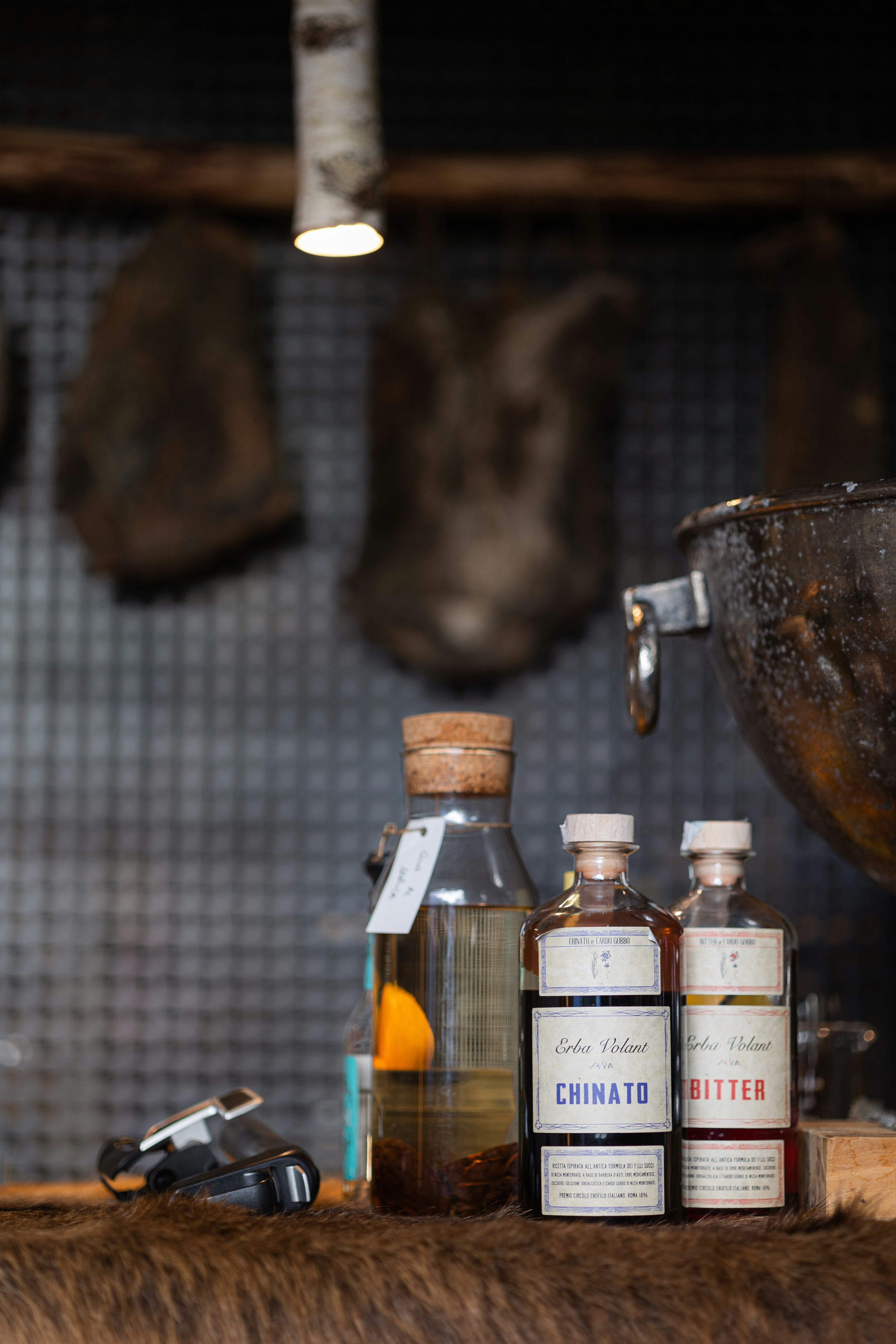 Amber Bottles and Copper Topography on a Rustic Workbench
