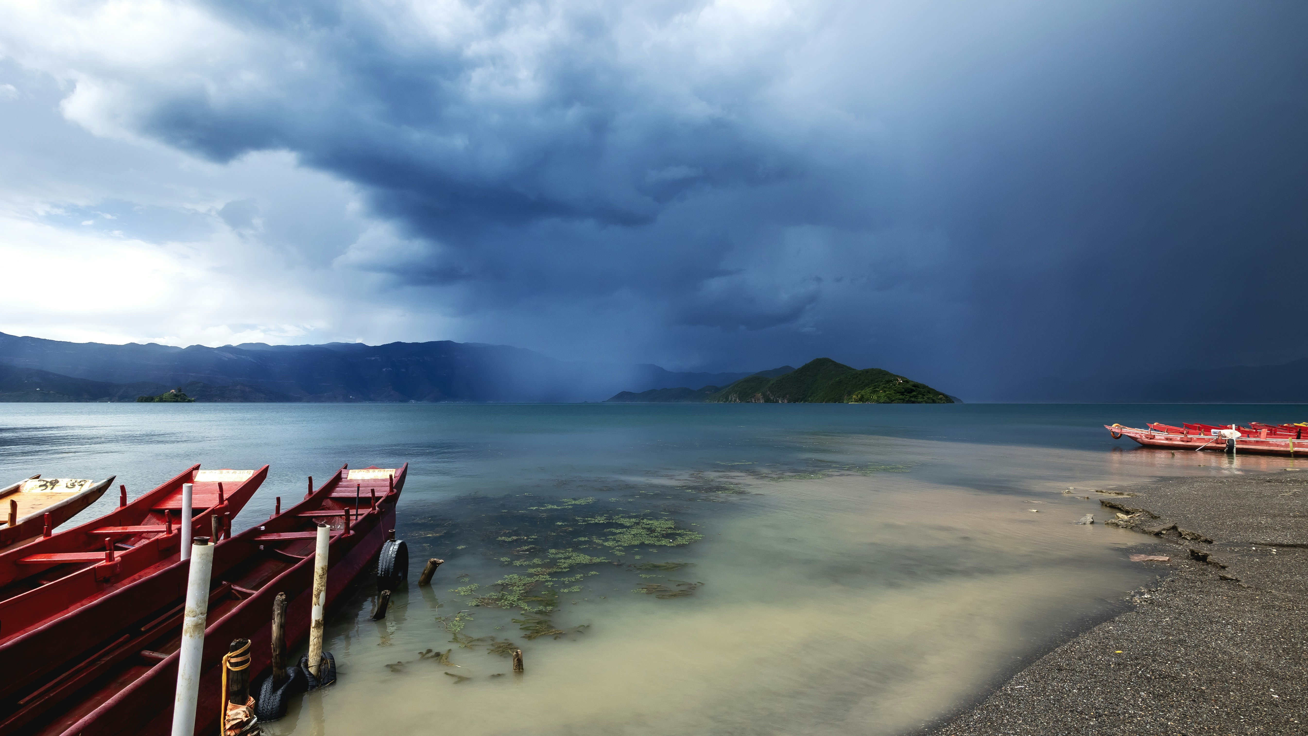 Stormfront Over a Glassy Lake: Red Dories at the Shore