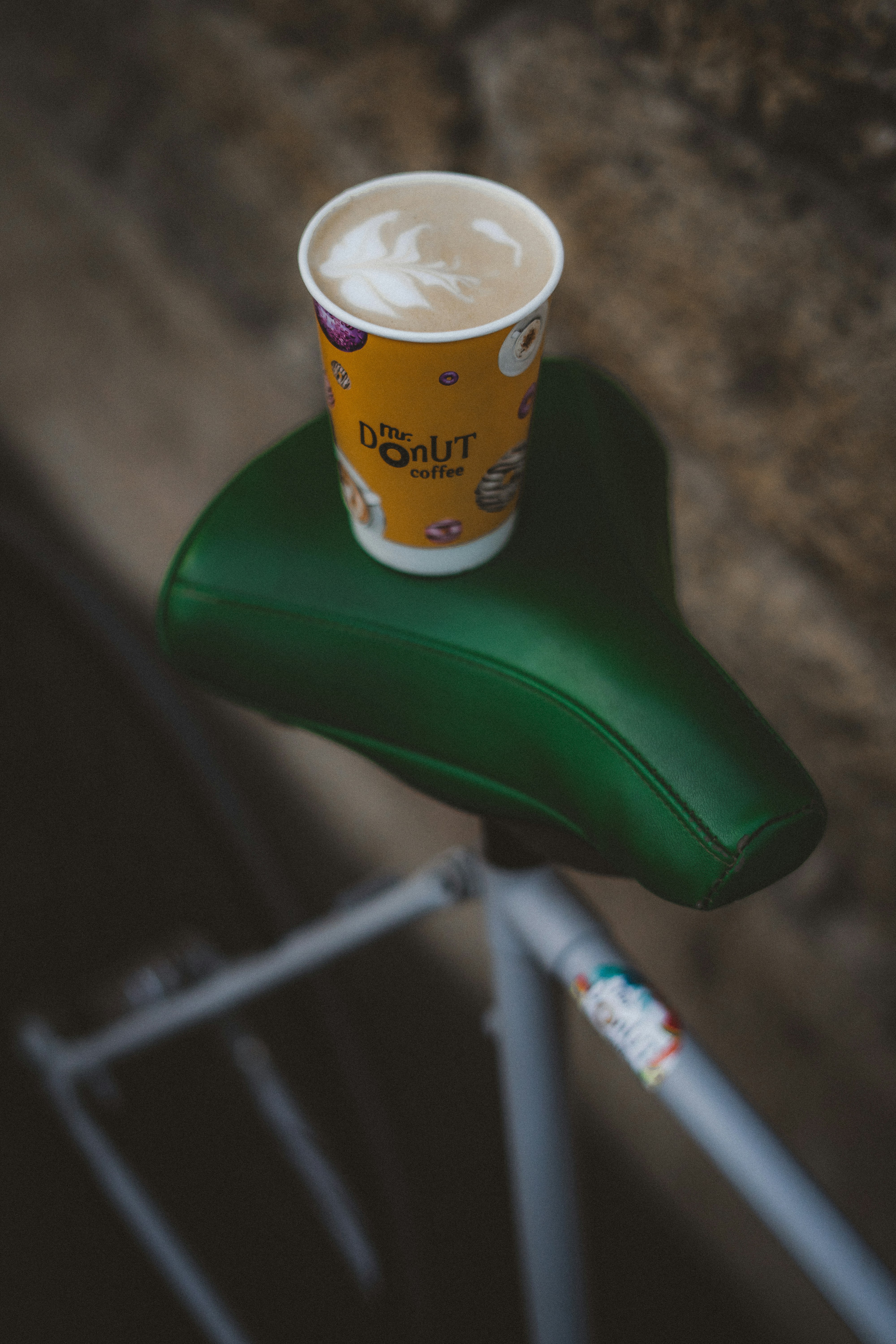 Latte on the Saddle: a coffee cup perched on a bicycle seat