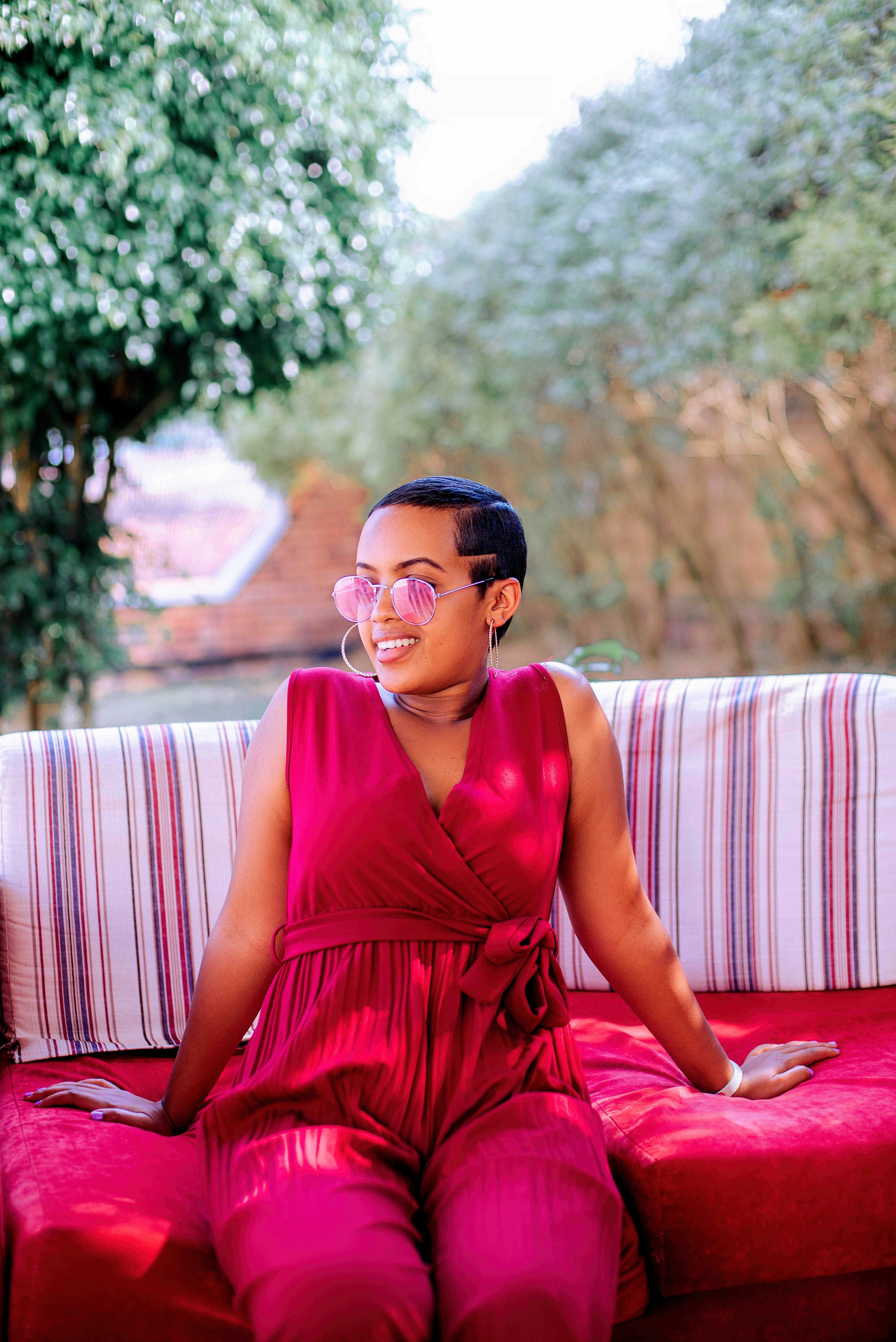 Woman in red tank top sitting on couch photo – Free Portrait ...