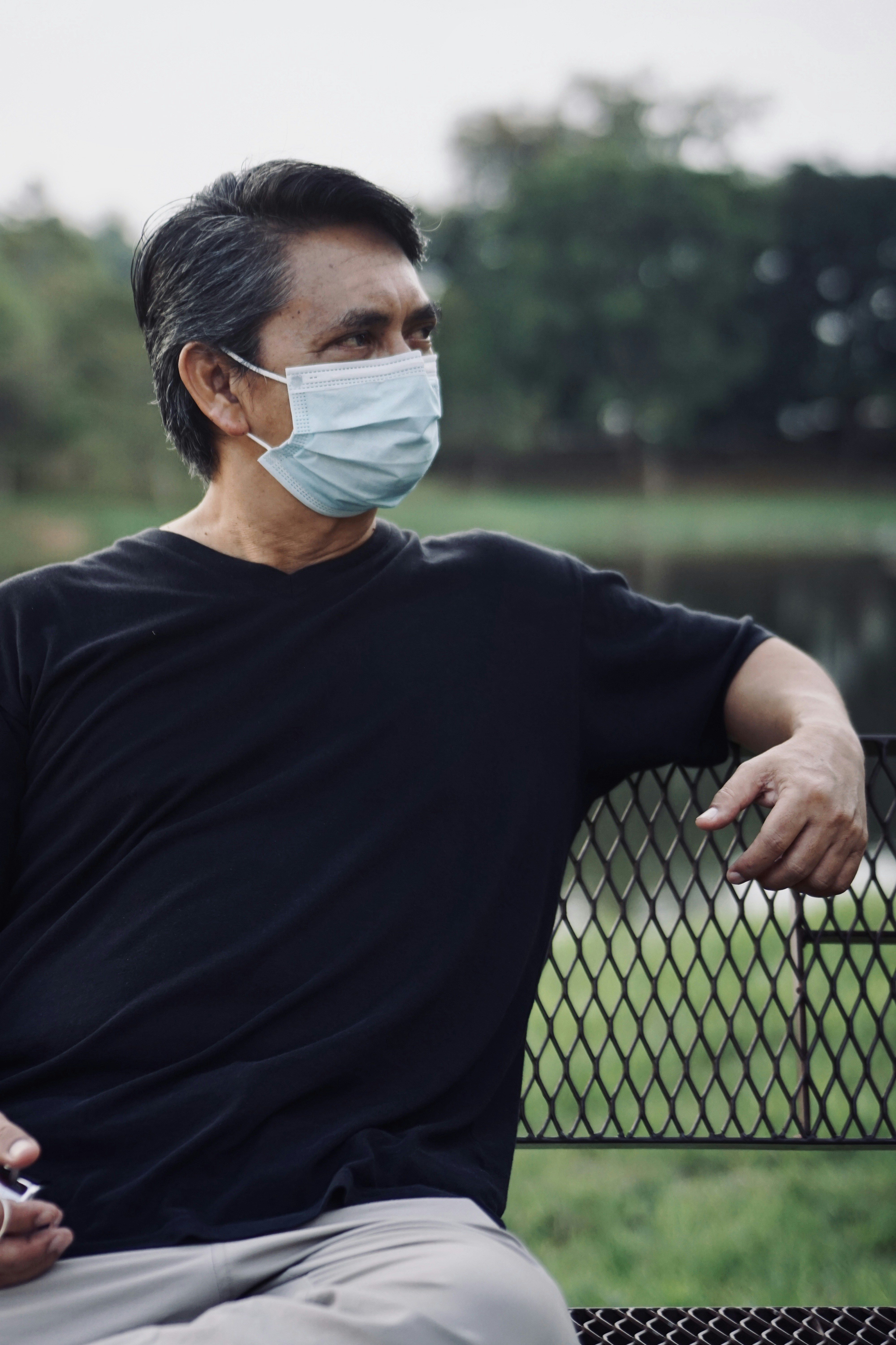 Masked Portrait on a Parkbench: Calm Confidence Outdoors