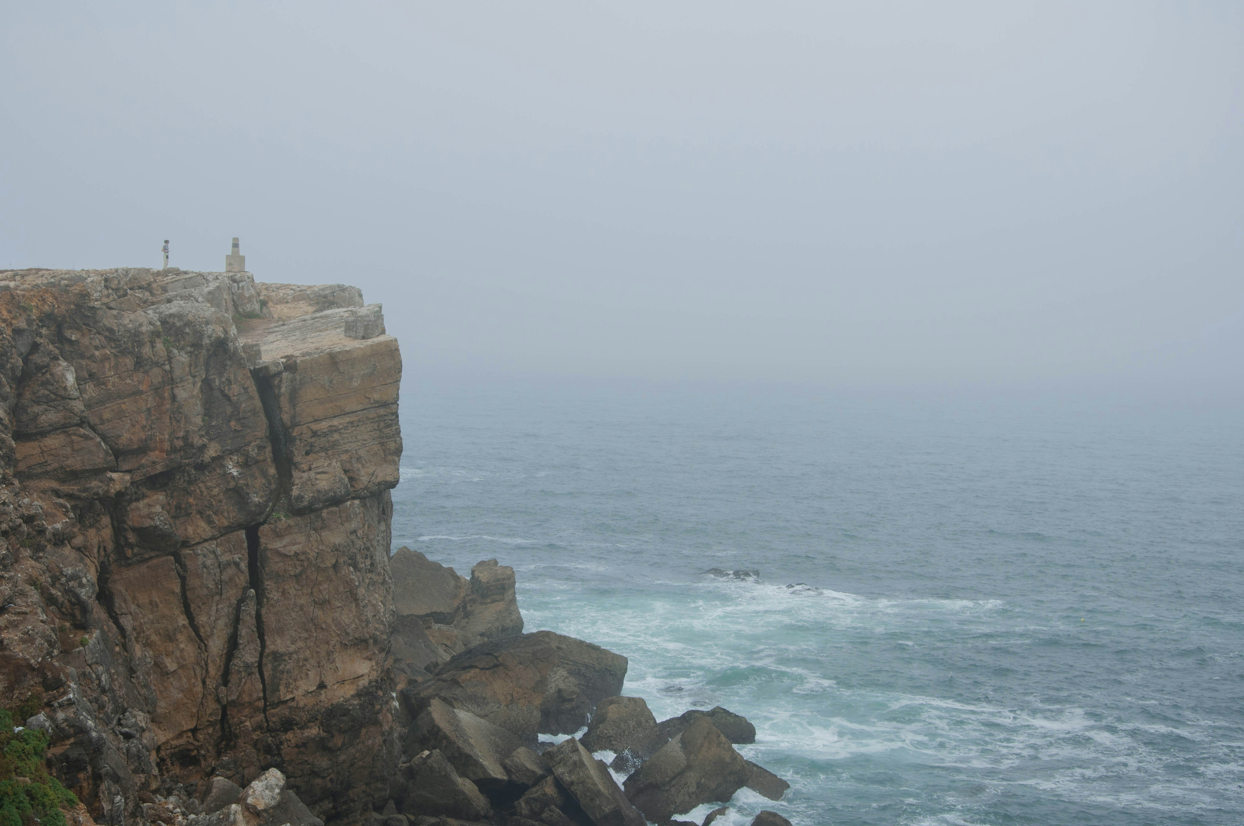 Harbor of Silence: A Lone Figure on a Windswept Cliff