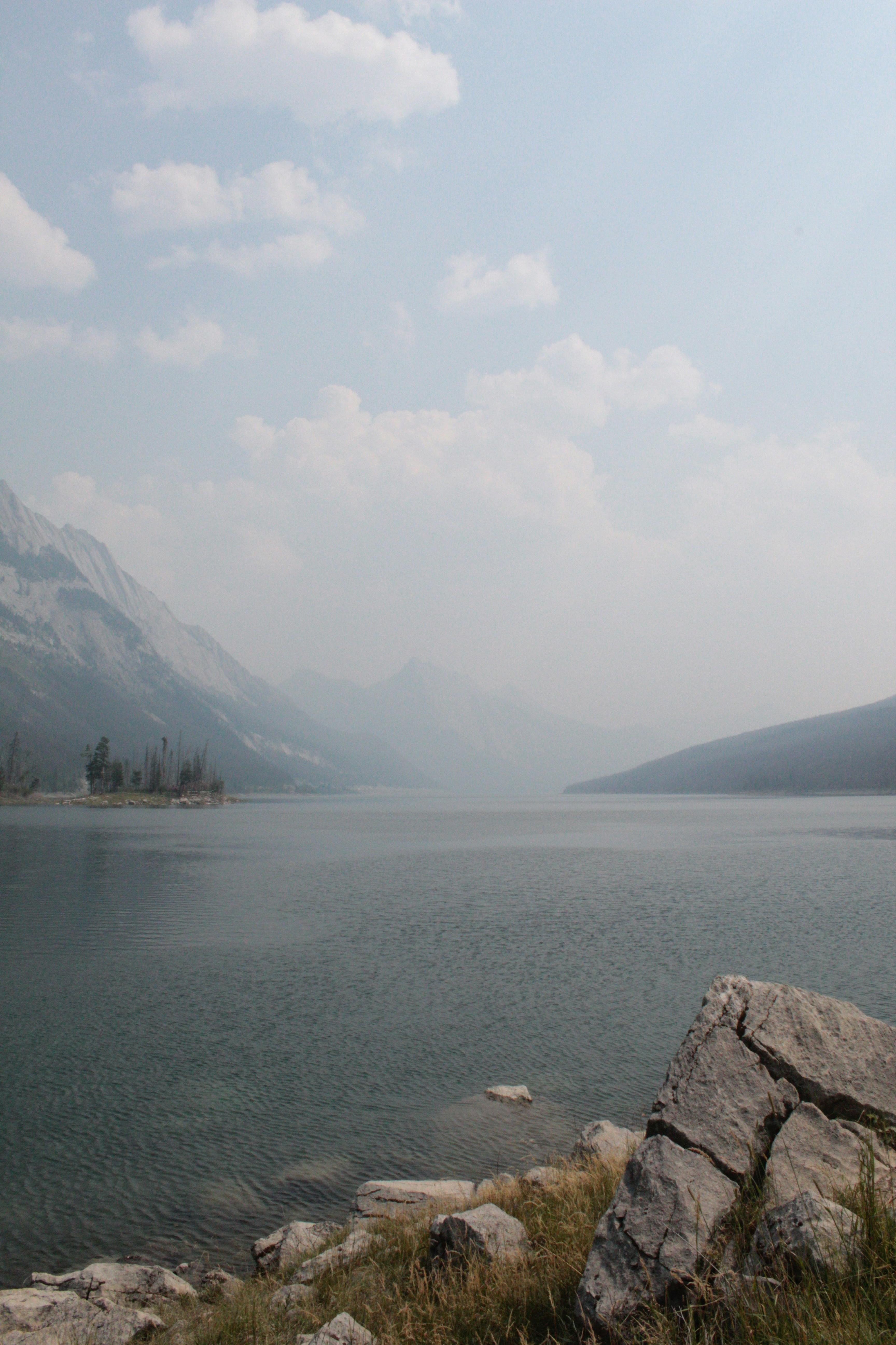 Mist-Lapped Peaks Reflected in a Calm Alpine Lake