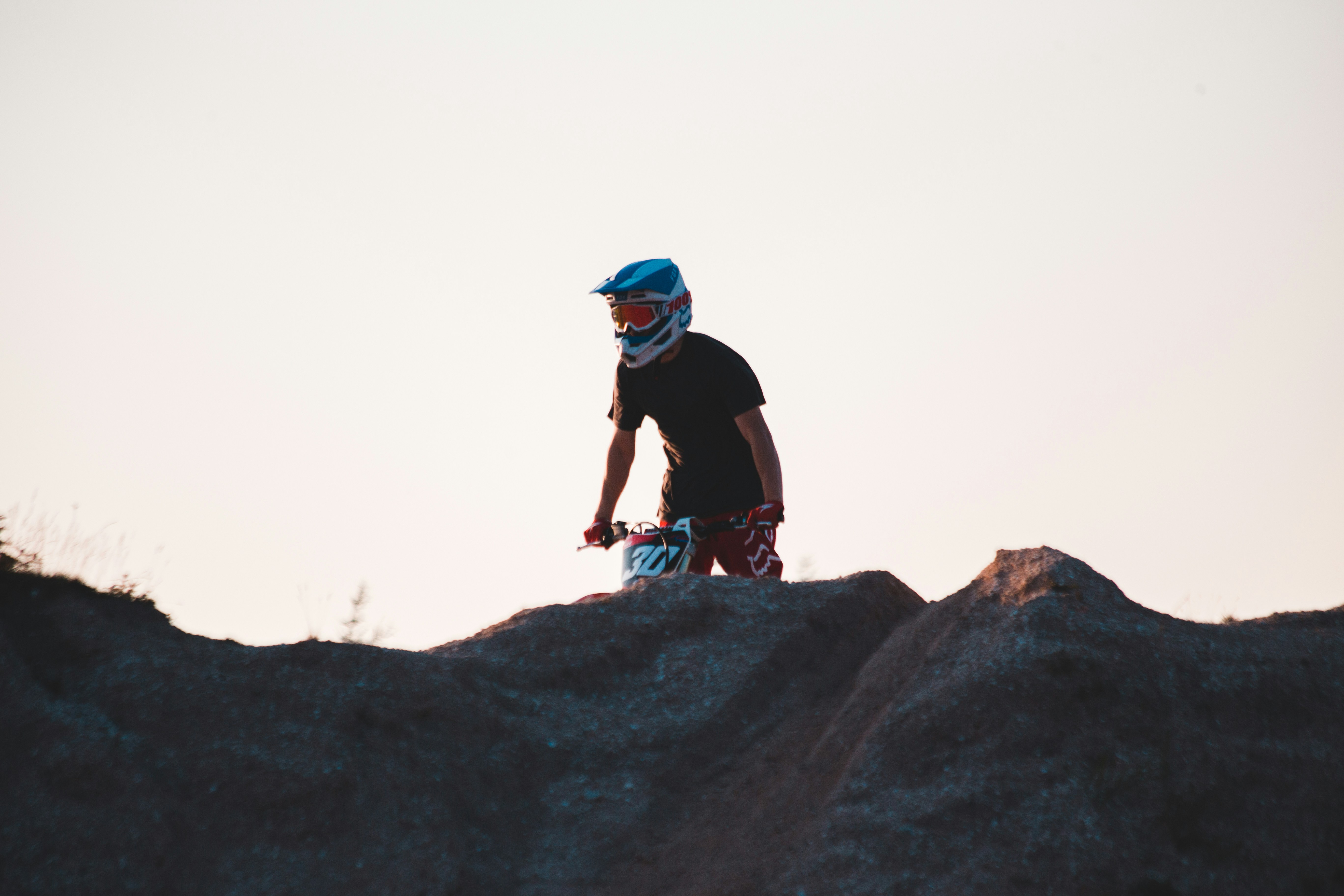 Rider at the Crest: silhouette against a pale horizon