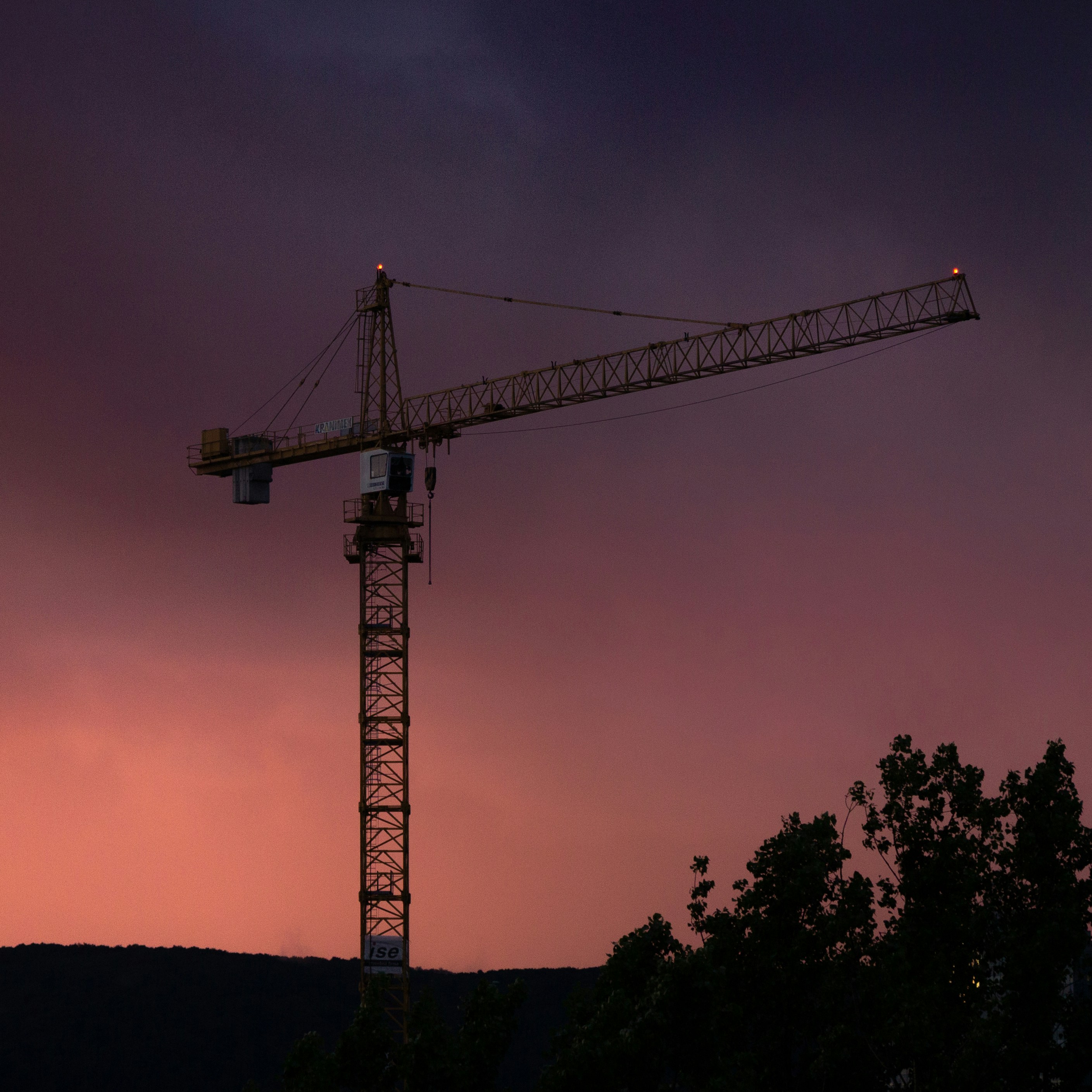 Crane Silhouette at Sunset: Steel Spine Against a Velvet Sky