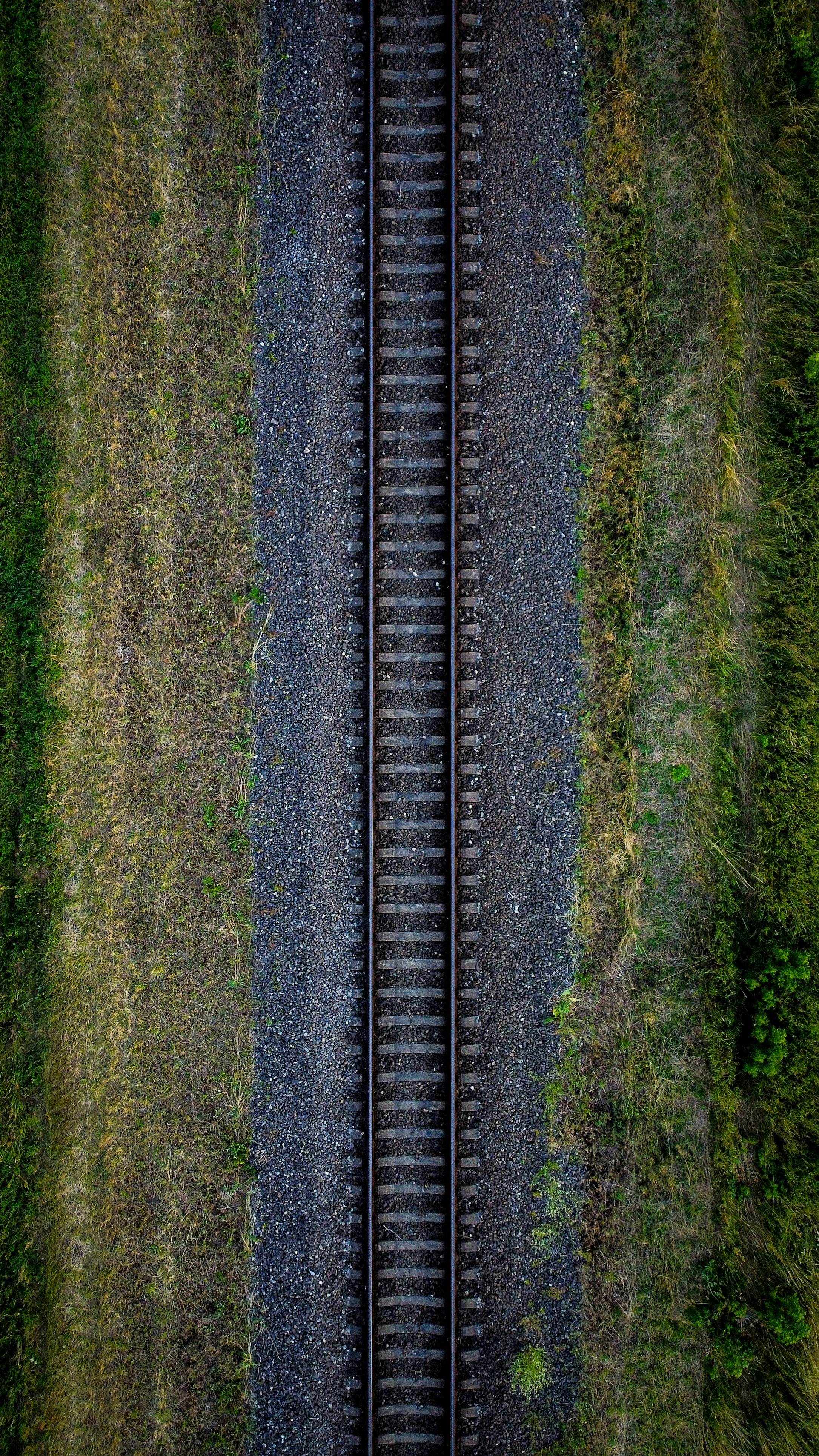 Railway road | green grass field during daytime