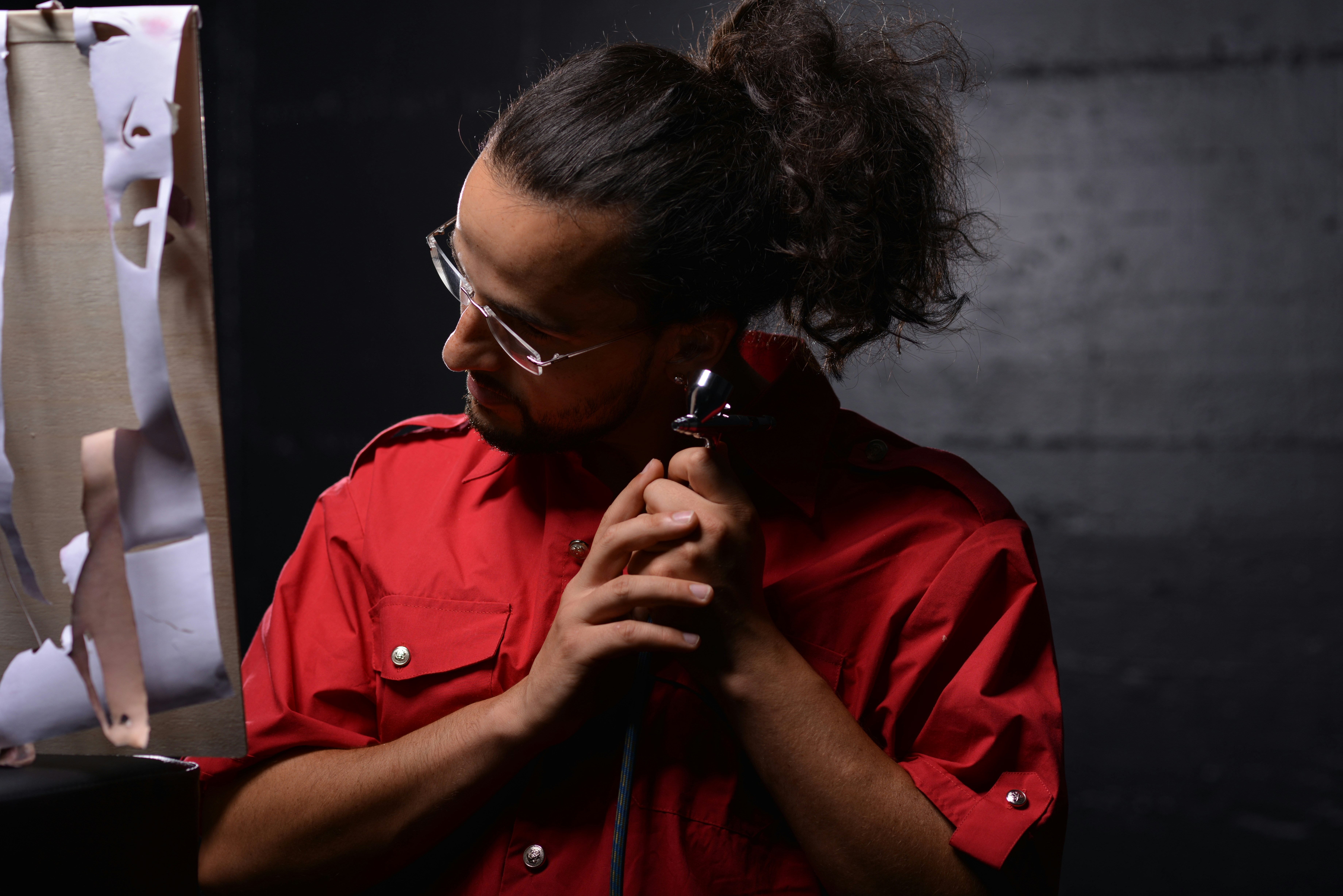 Red-Handed Focus: A Mic Check in a Dim Studio