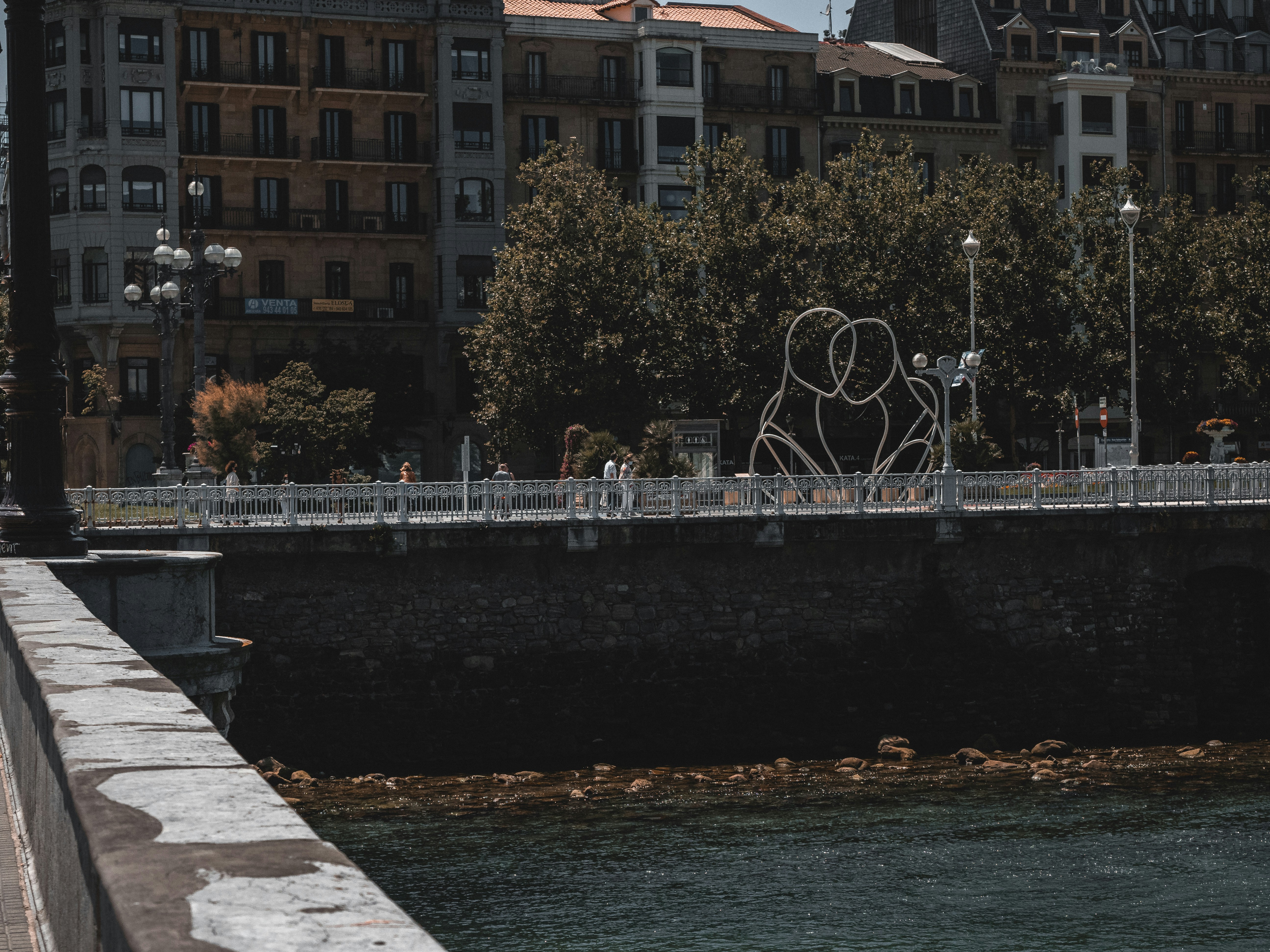 brown concrete building near body of water during daytime