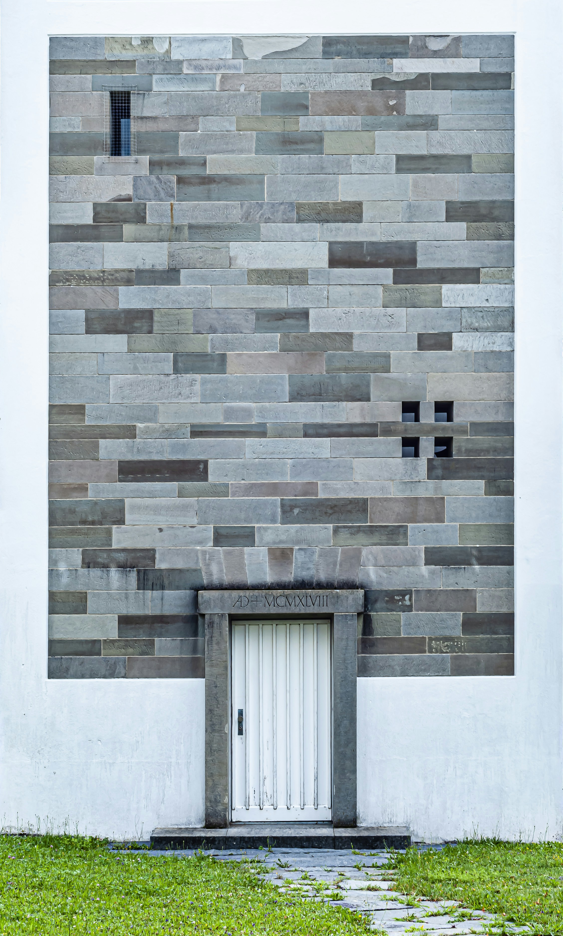 Slate-Brick Mosaic Framing a Central Door: An Architectural Quiet