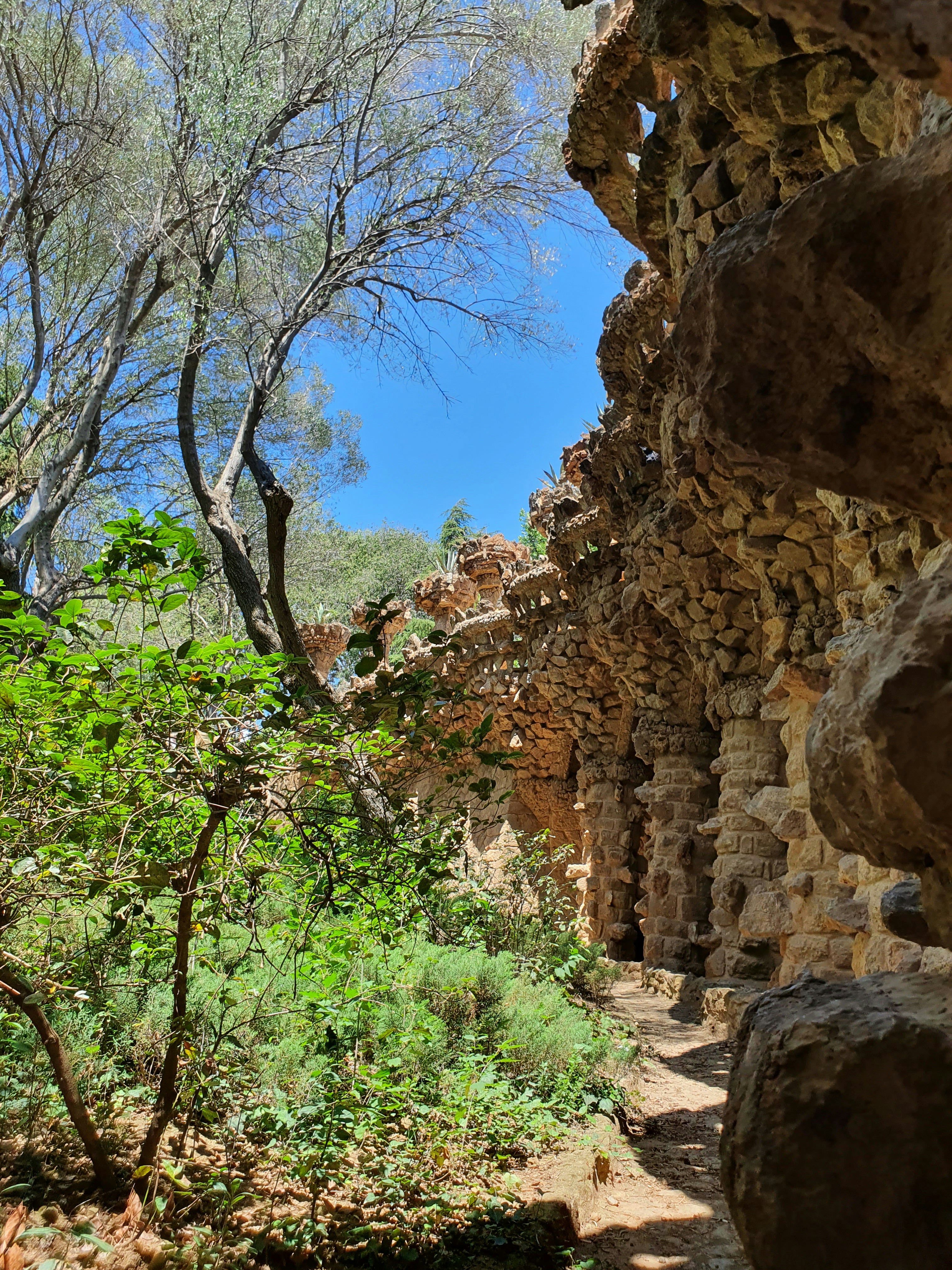Sunlit Ruins Framed by Greenery: A Passage Through Ancient Arches