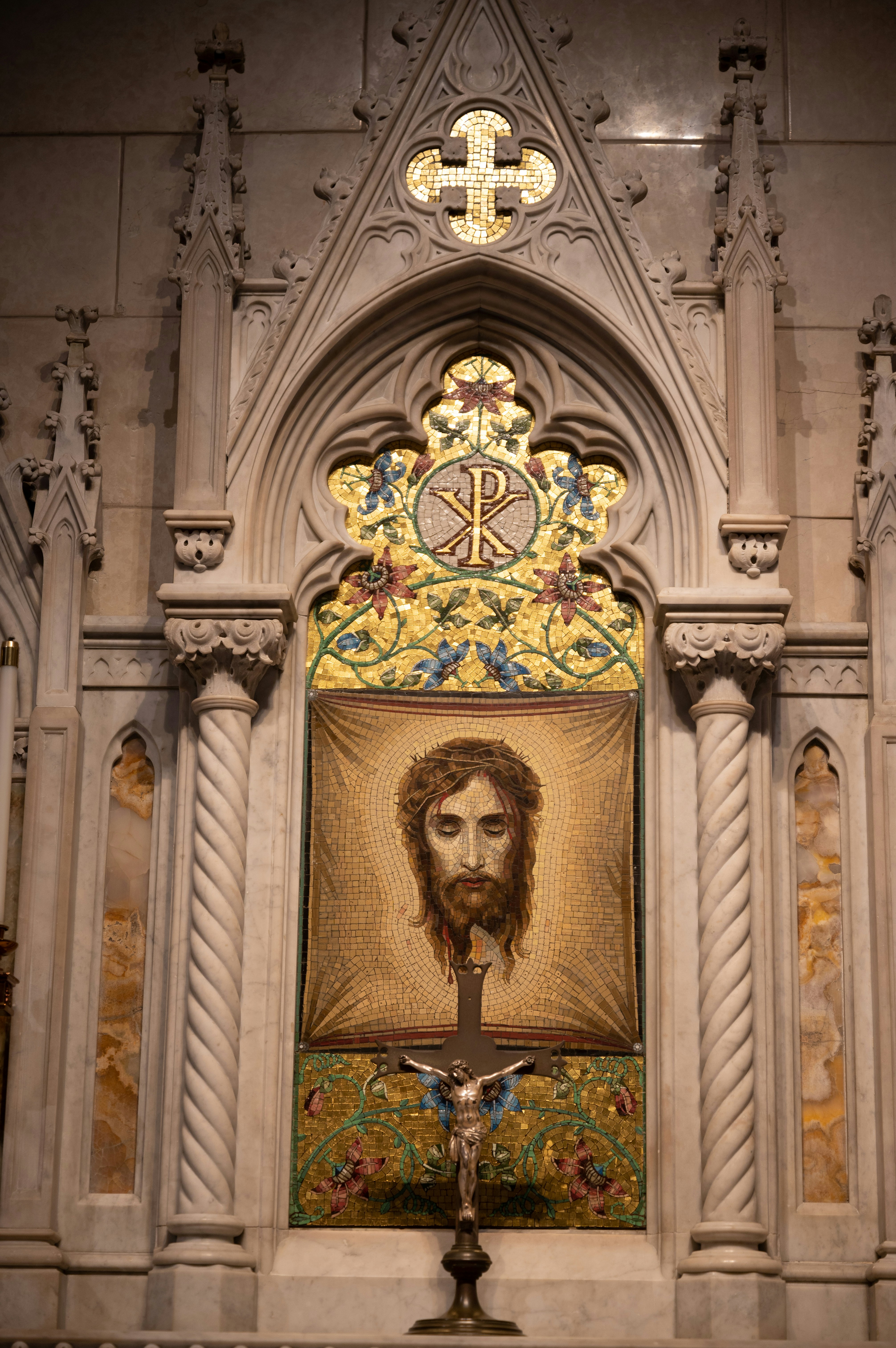 Mosaic of sorrow: Christ on the gilded panel beneath Gothic arches
