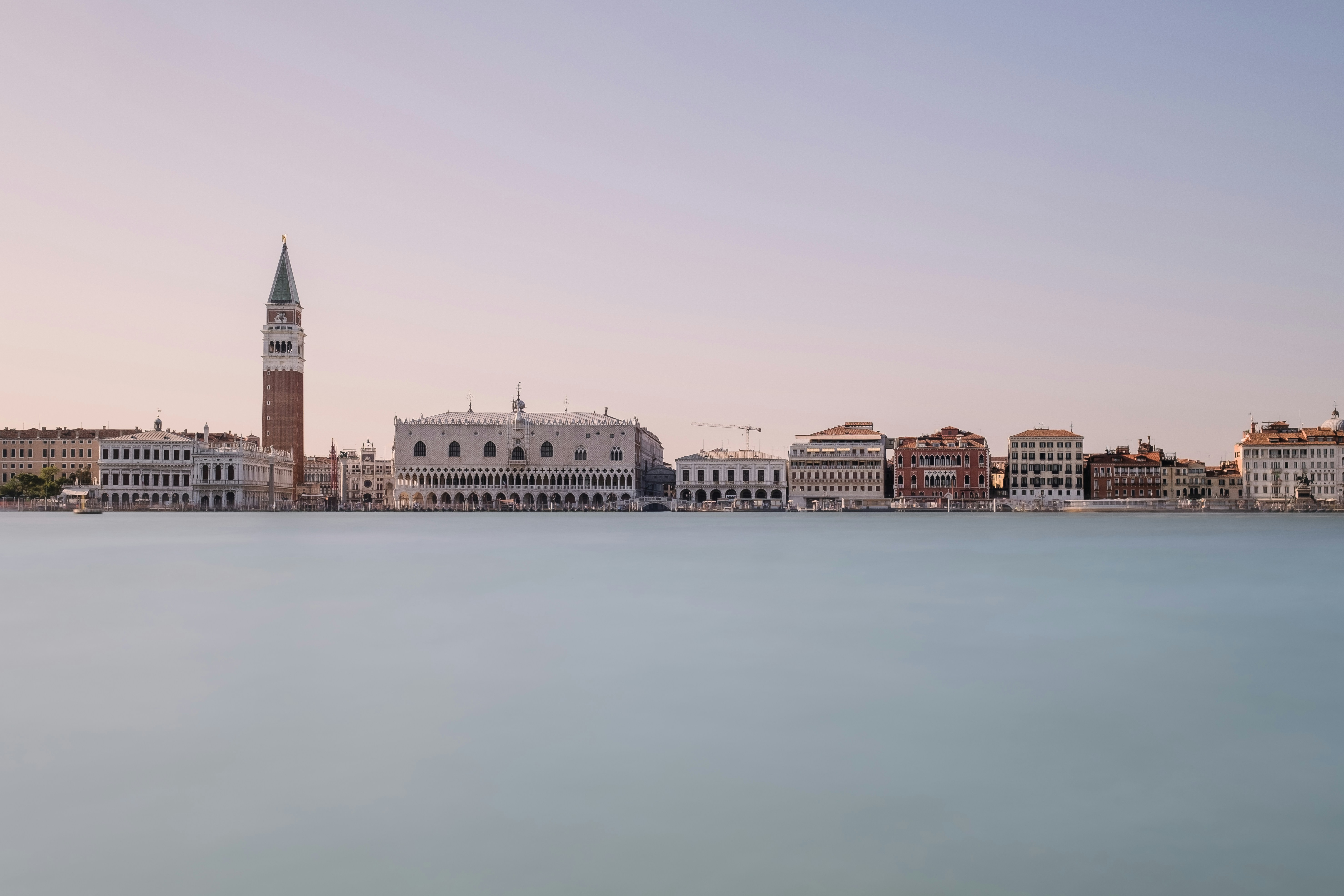 White concrete building near body of water during daytime photo – Free ...