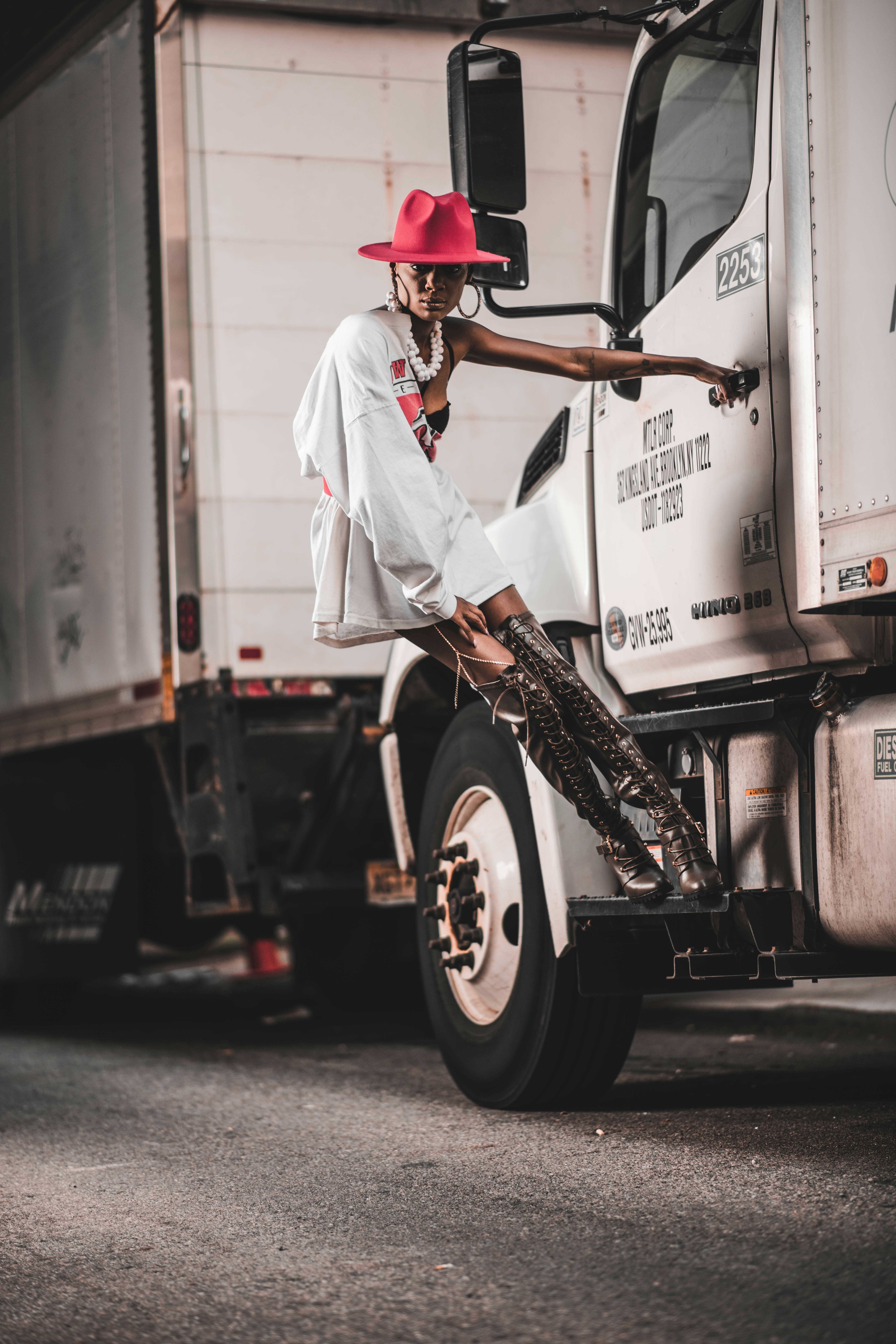 Red Hat, White Garb: A Solo Stunt Beside the Truck