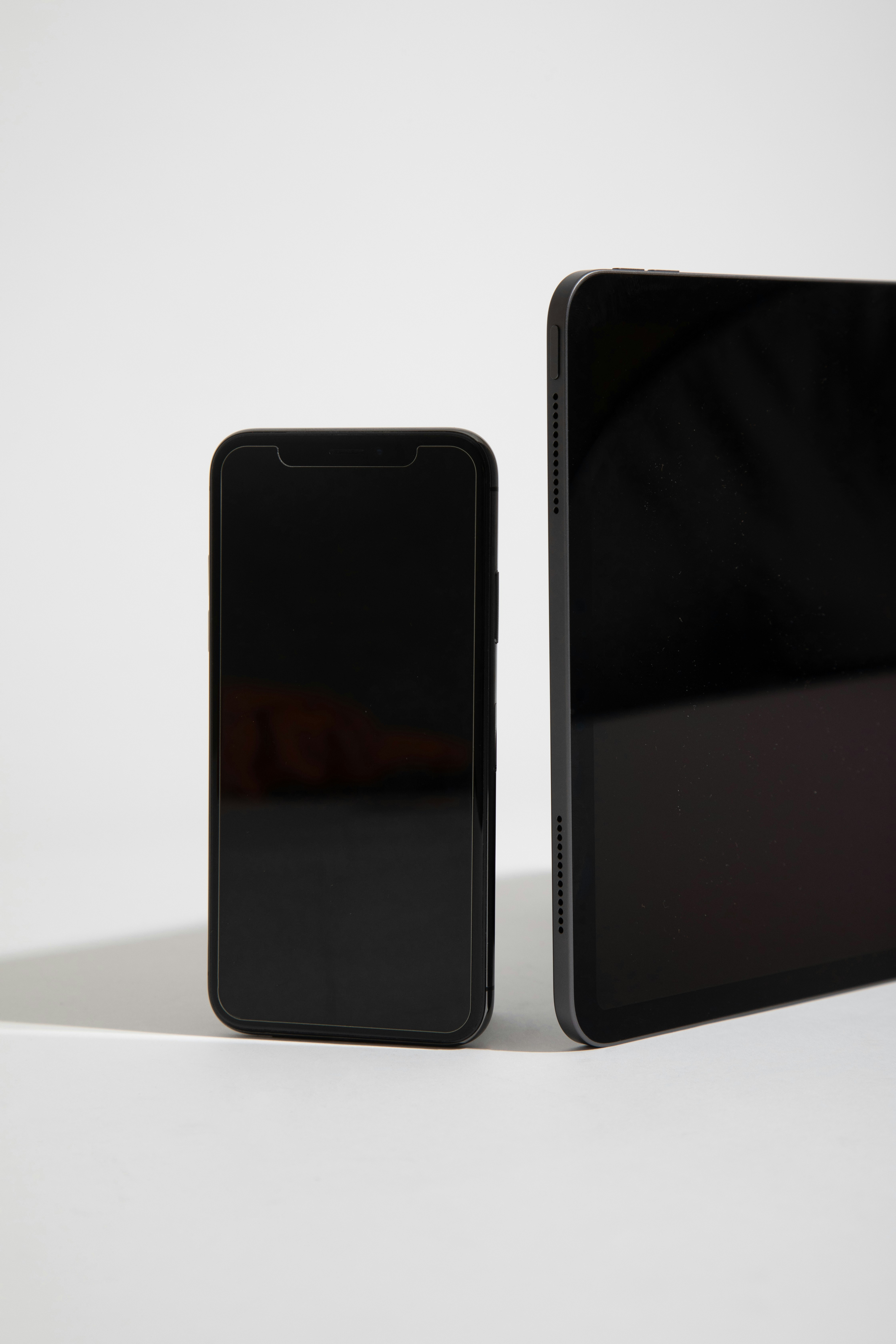 Black android smartphone on white table photo – Free Iphone Image on ...