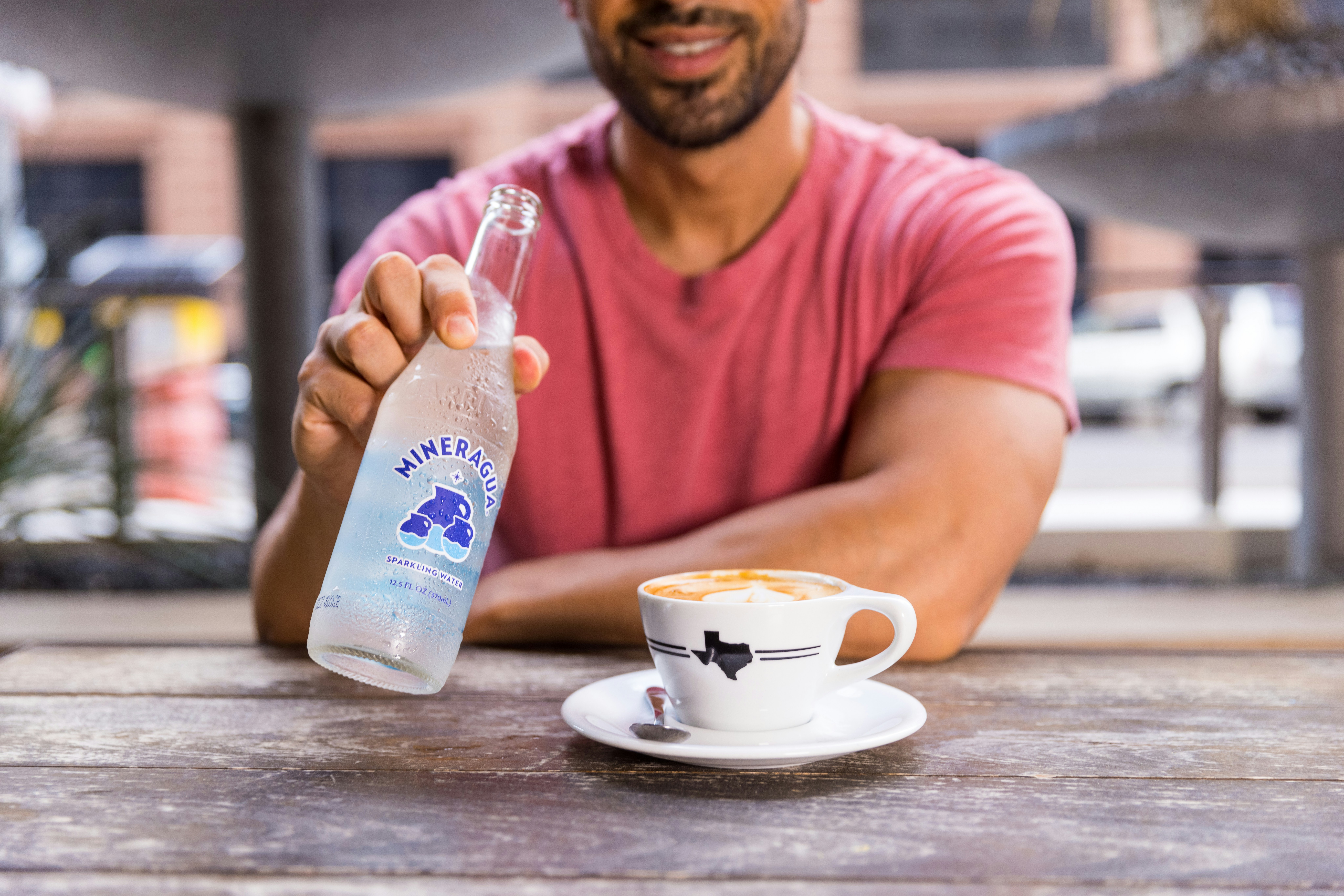 Mineral Water and Espresso on a Sunlit Outdoor Café Table