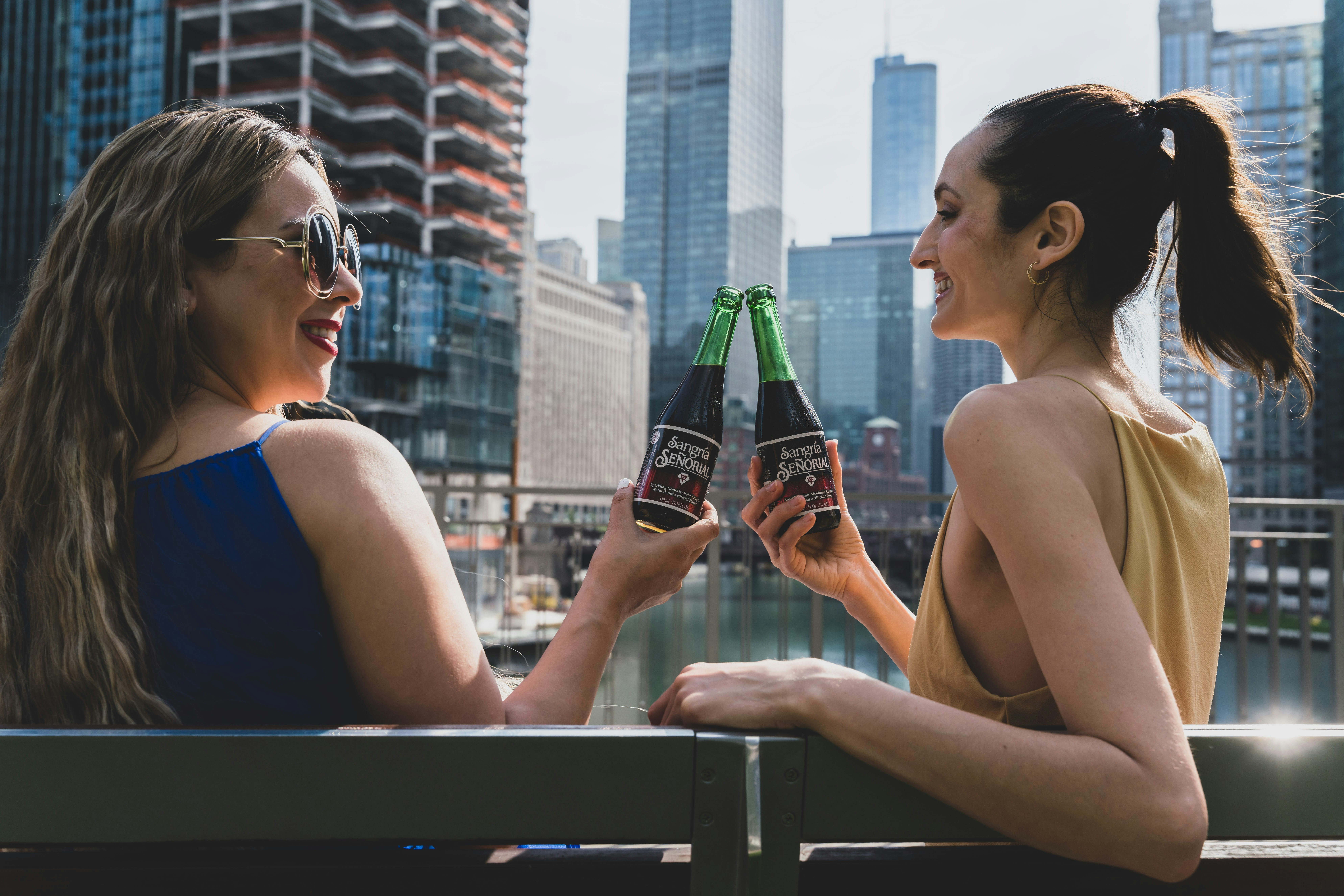 Rooftop cheers: friends toast with skyline backdrop