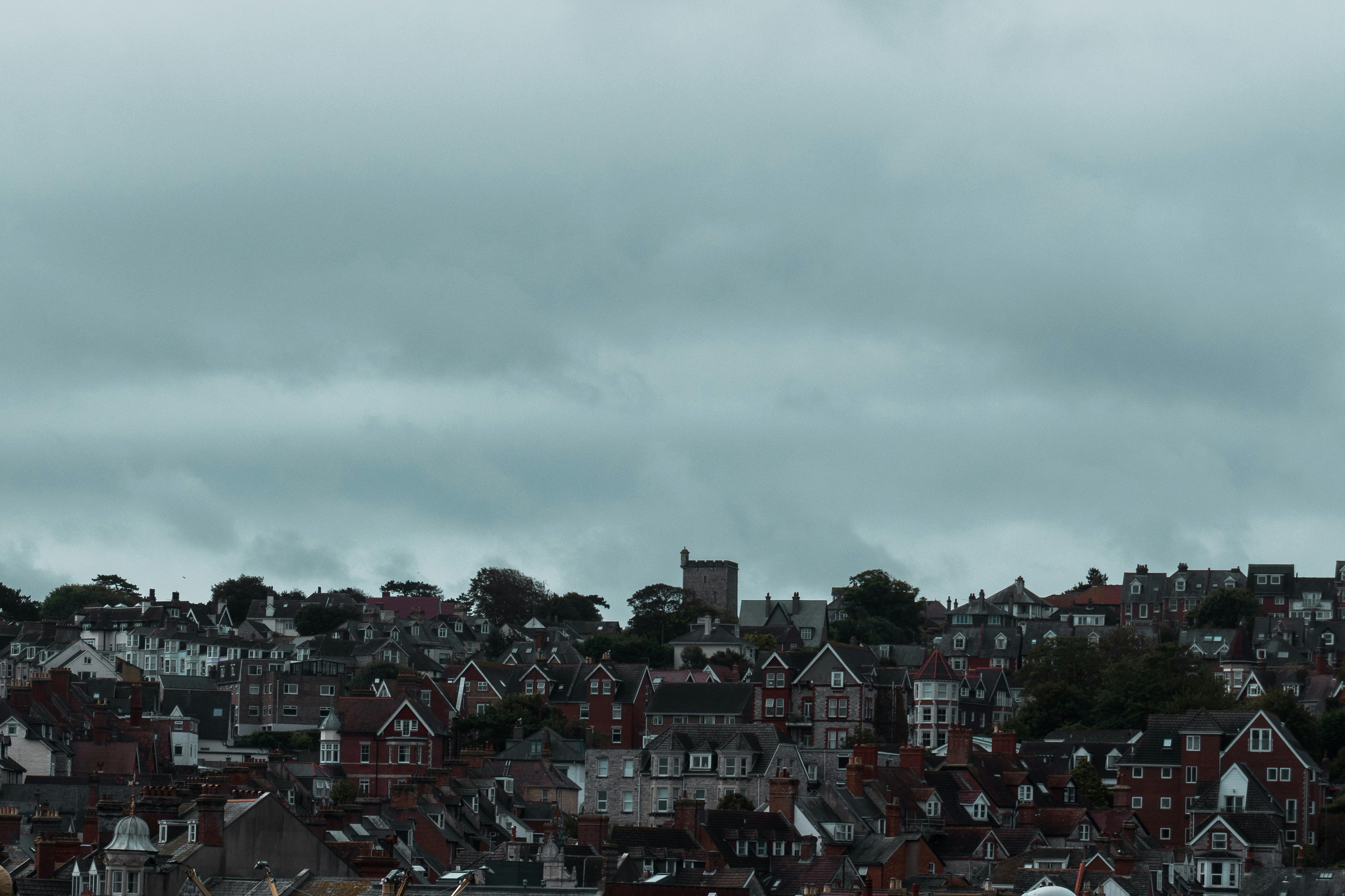 aerial view of city buildings under cloudy sky during daytime