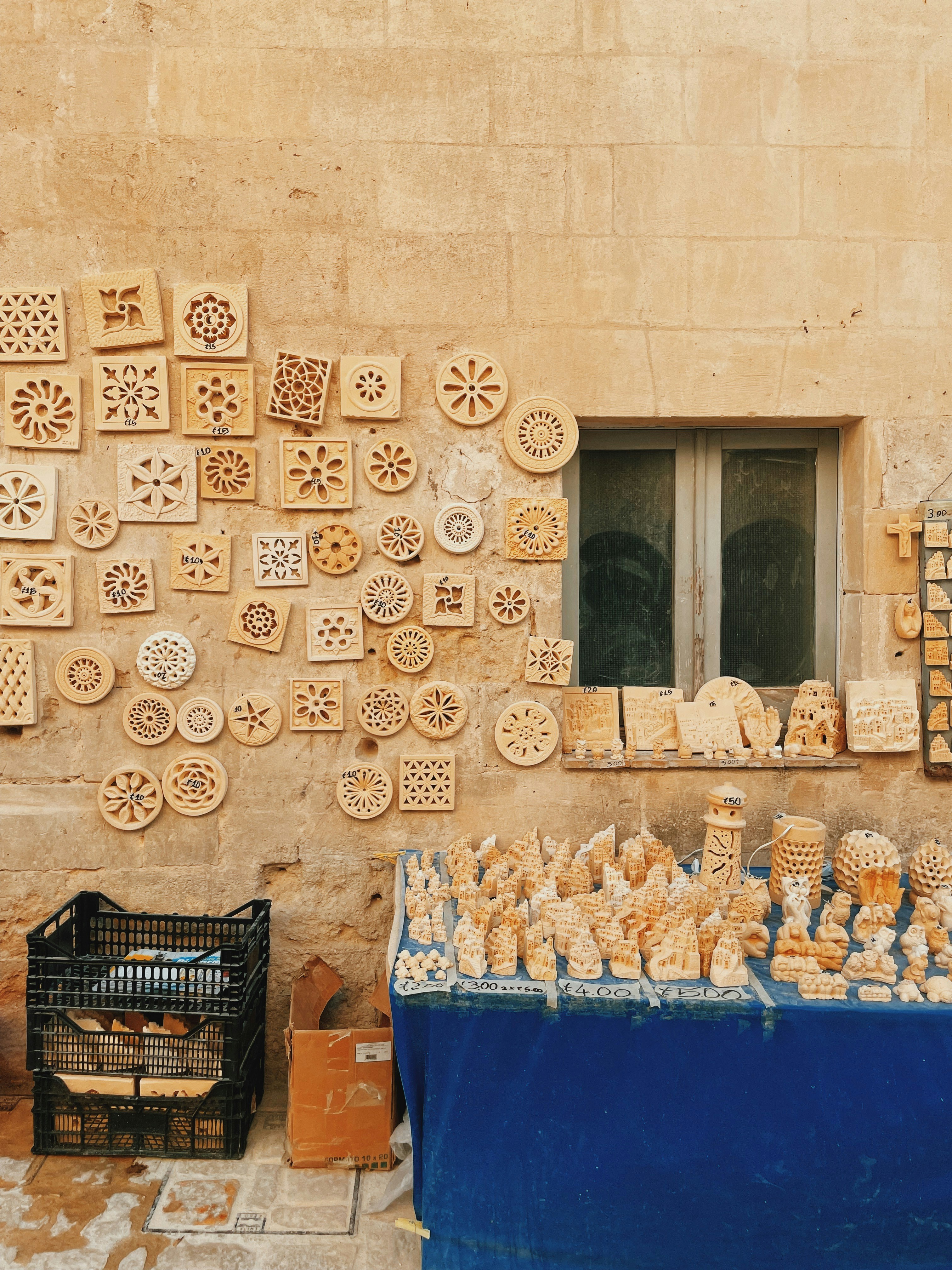 Sun-Dried Geometry: Tiles and Terracotta Ornaments on a Sunny Wall
