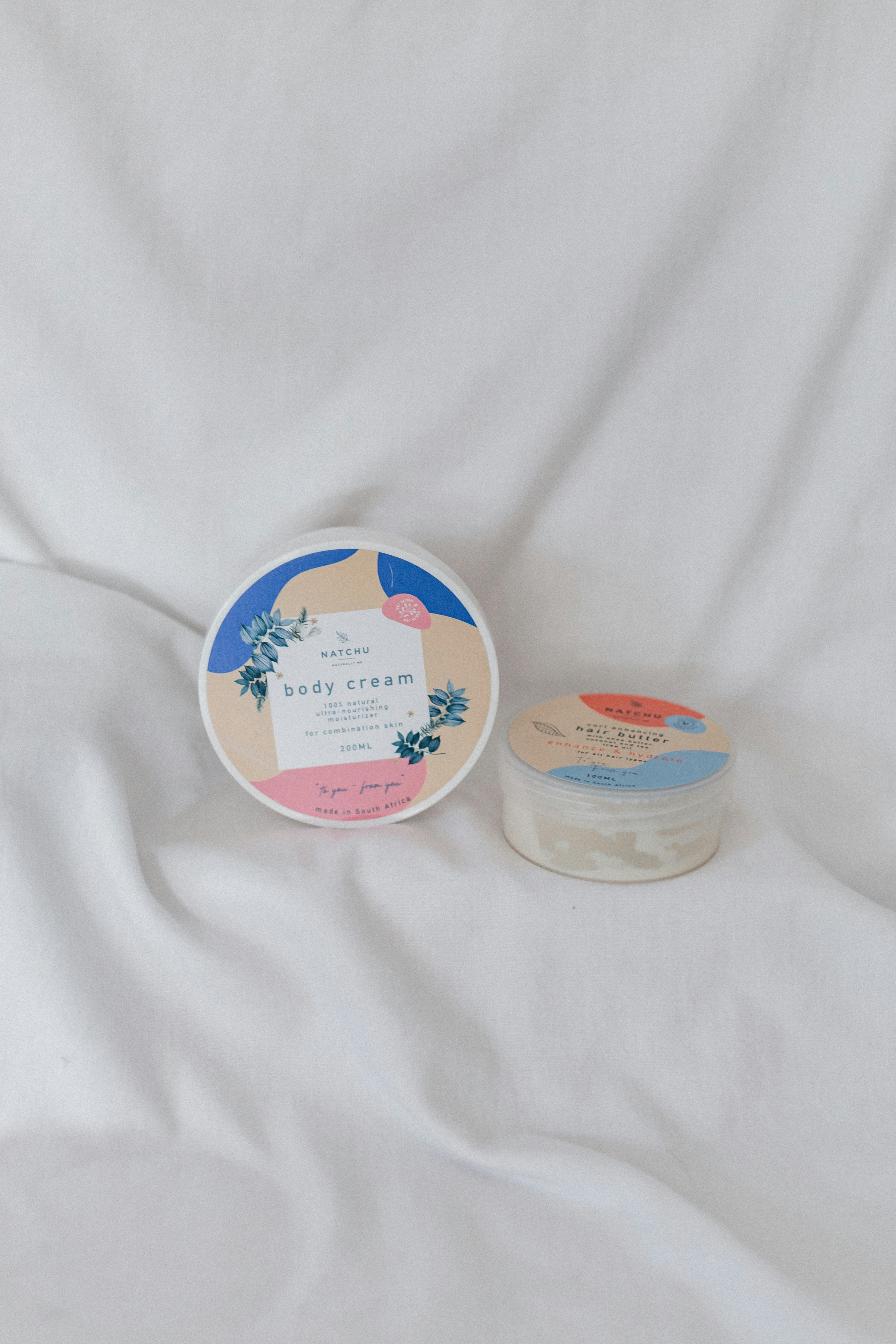 white and pink labeled round container