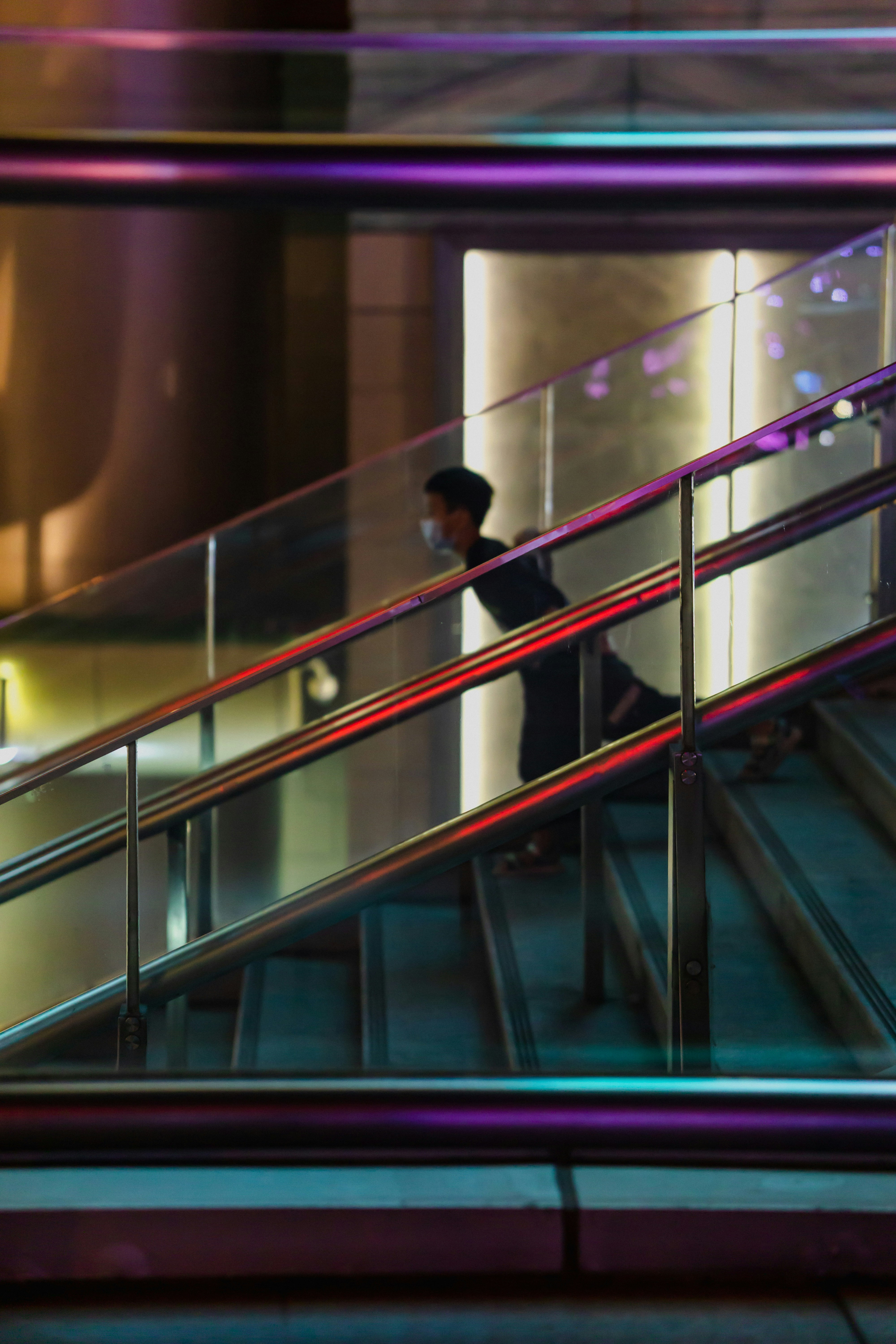 Man in black shirt standing on escalator photo – Free Human Image on ...