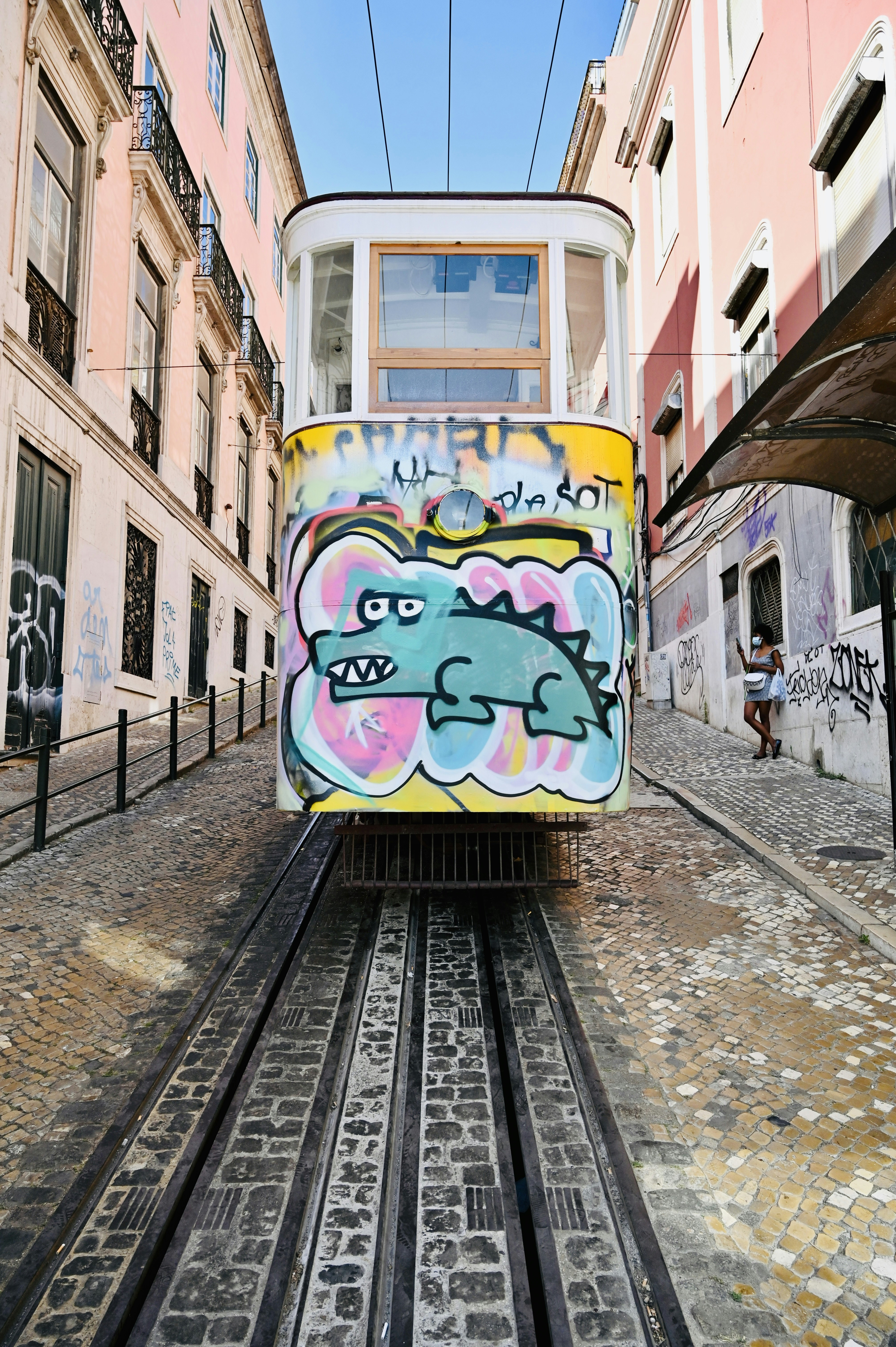 Neon Dragon Graffiti on a Tram Traversing Cobblestone Tracks