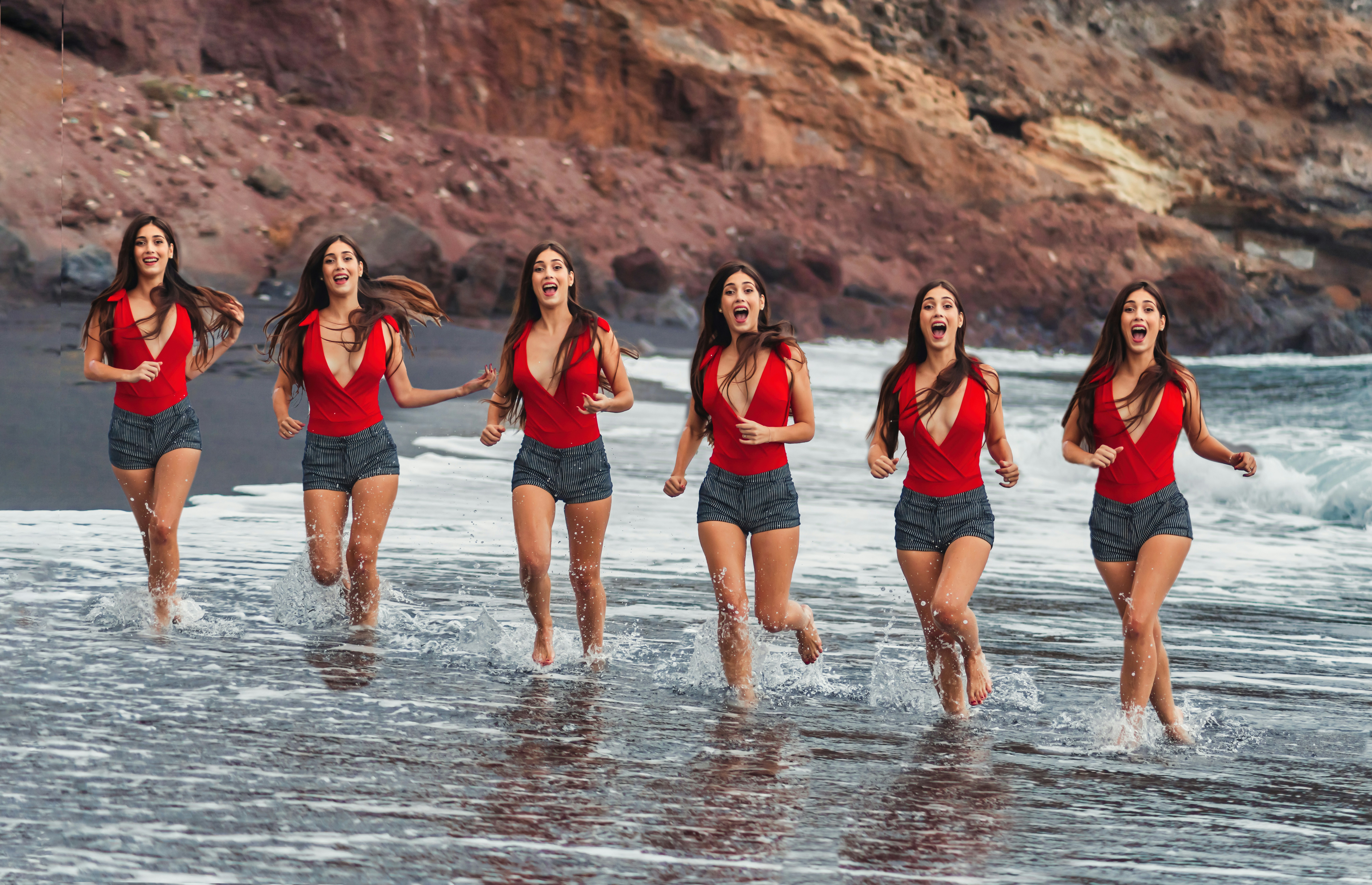 A group of women running in the water on a beach photo – Free Human ...