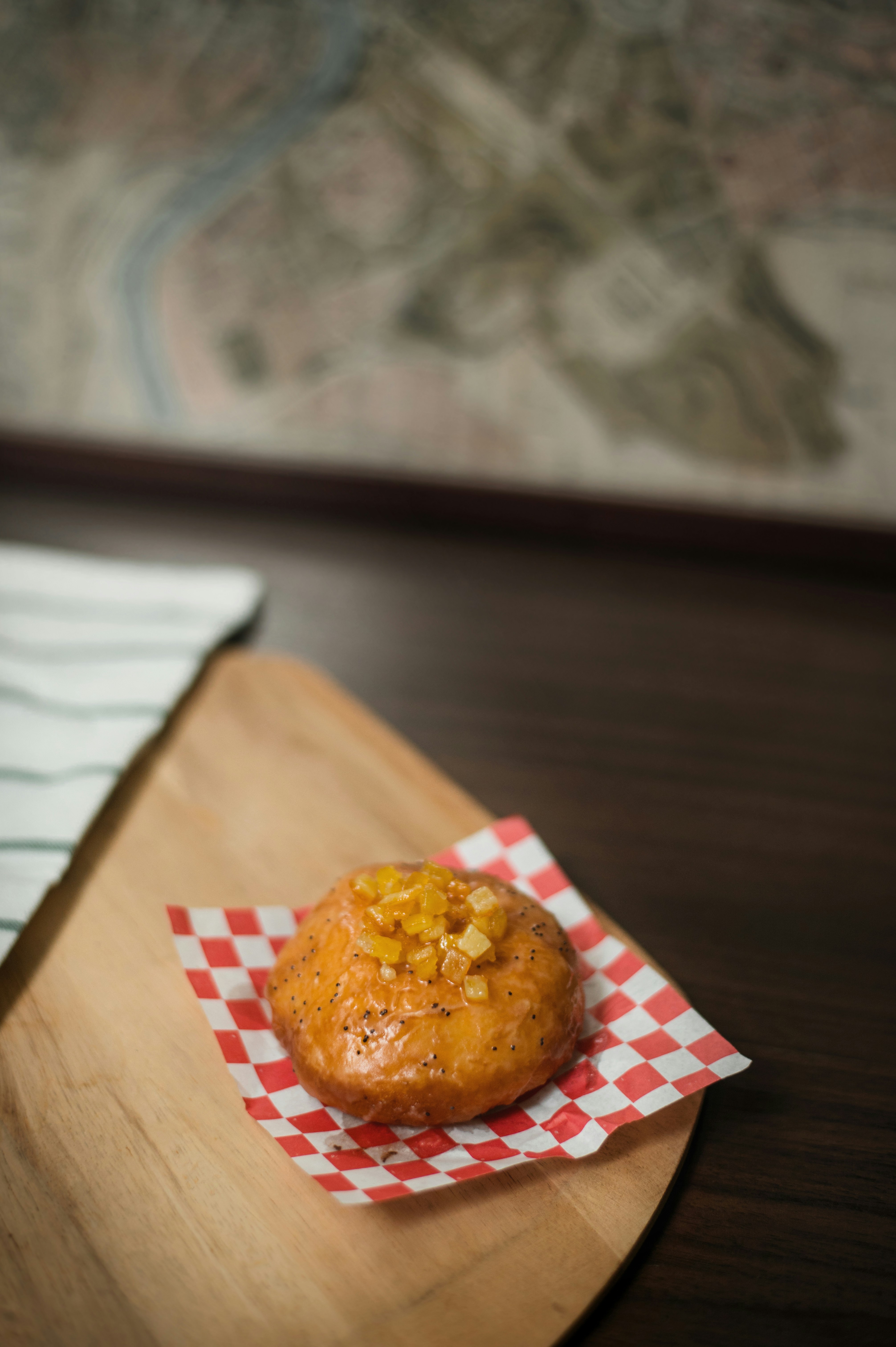 Candied Orange Crunch Donut on a Wooden Board