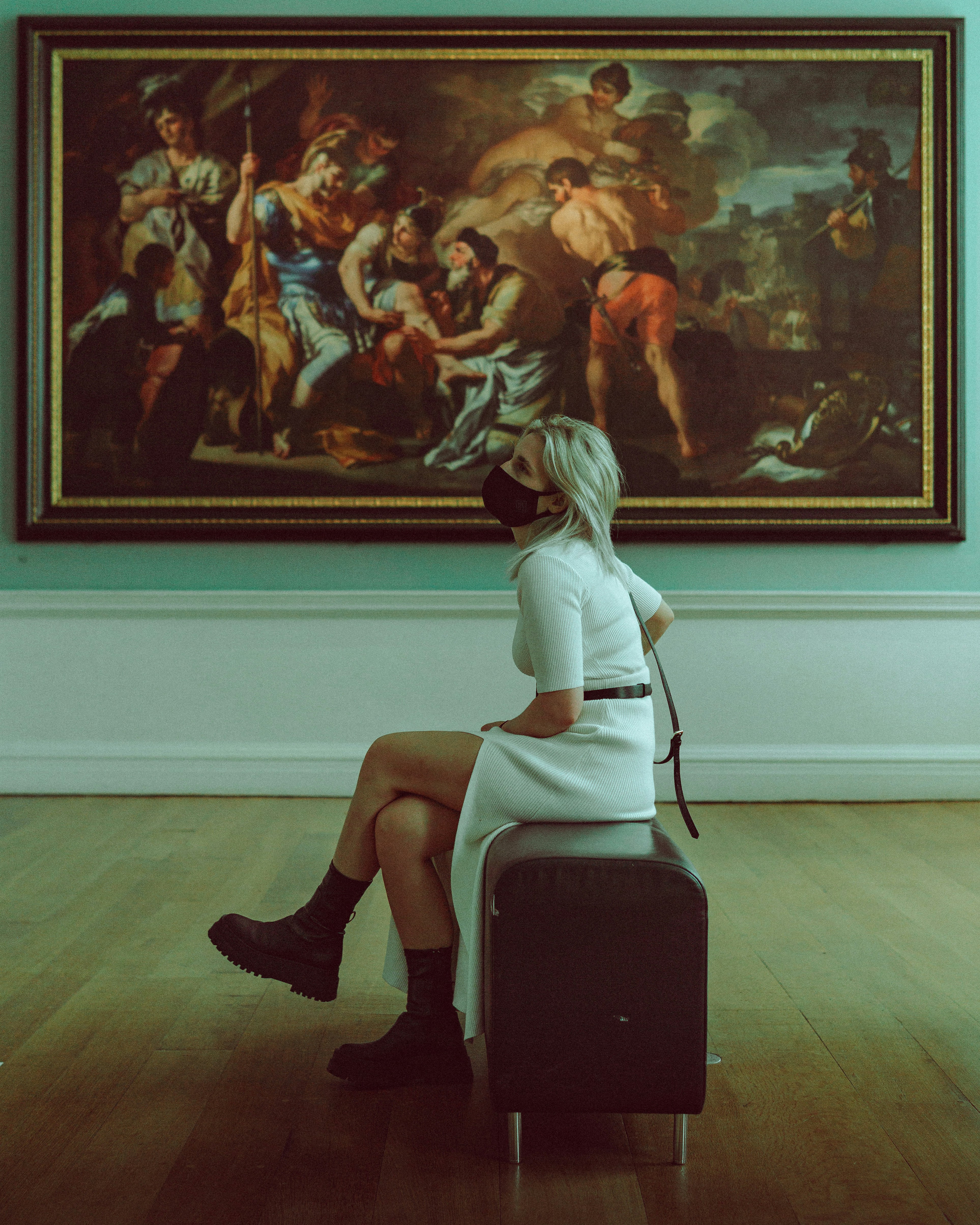Muse in the Gallery Seat: A Quiet Portrait with Masked Contemplation