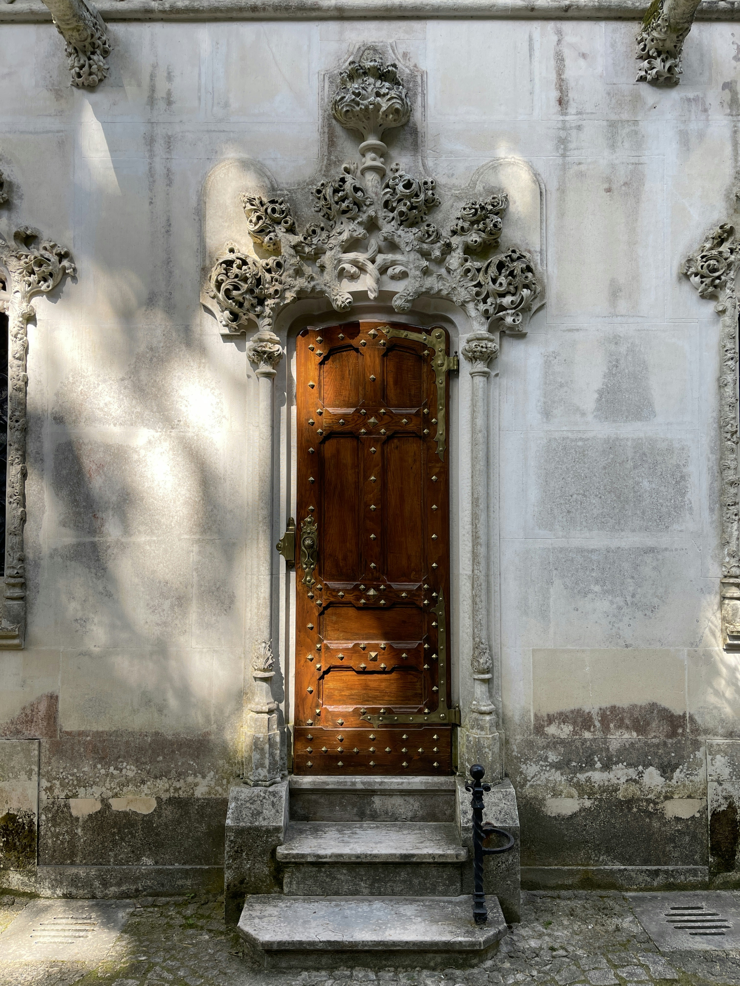 brown wooden door on white concrete wall
