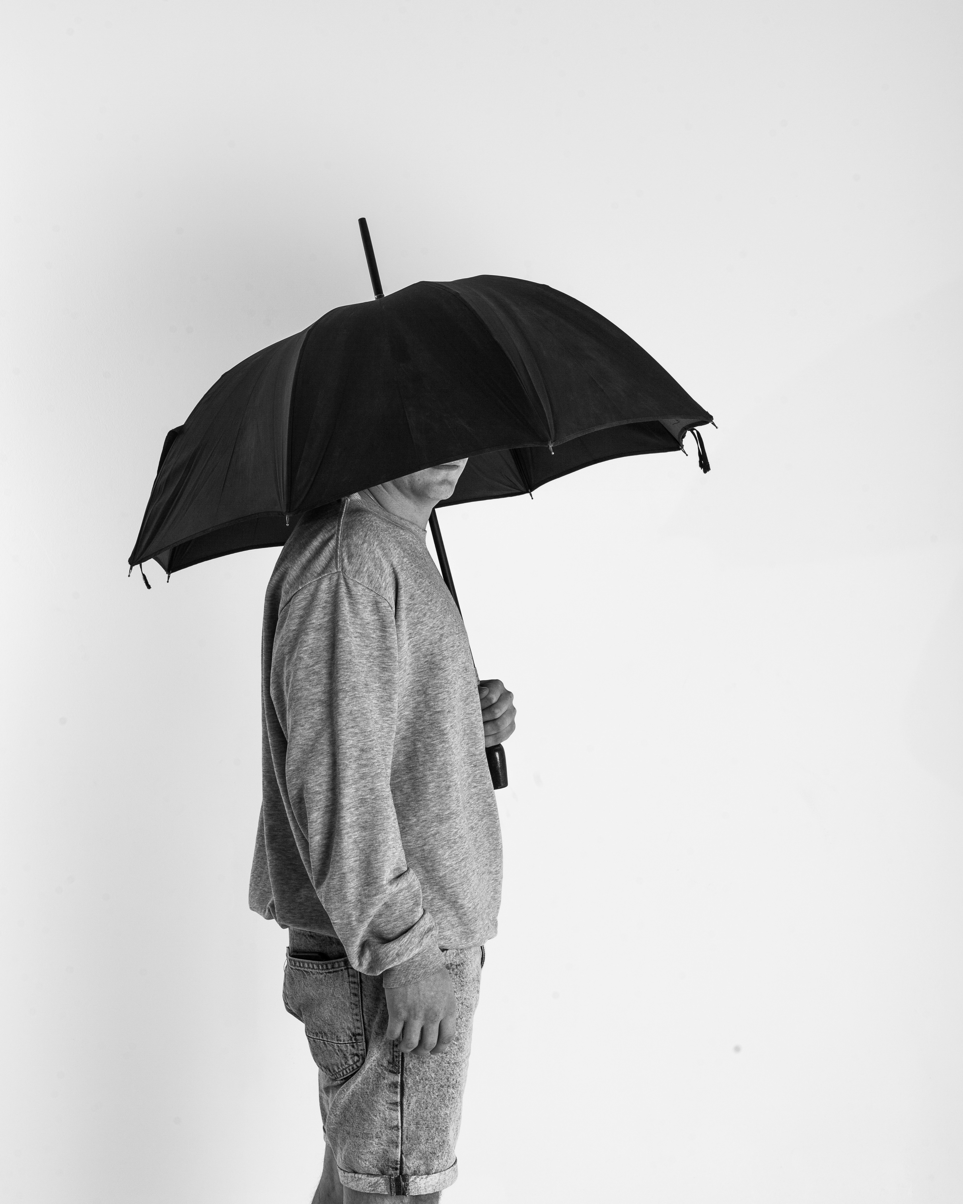 person in gray coat holding umbrella