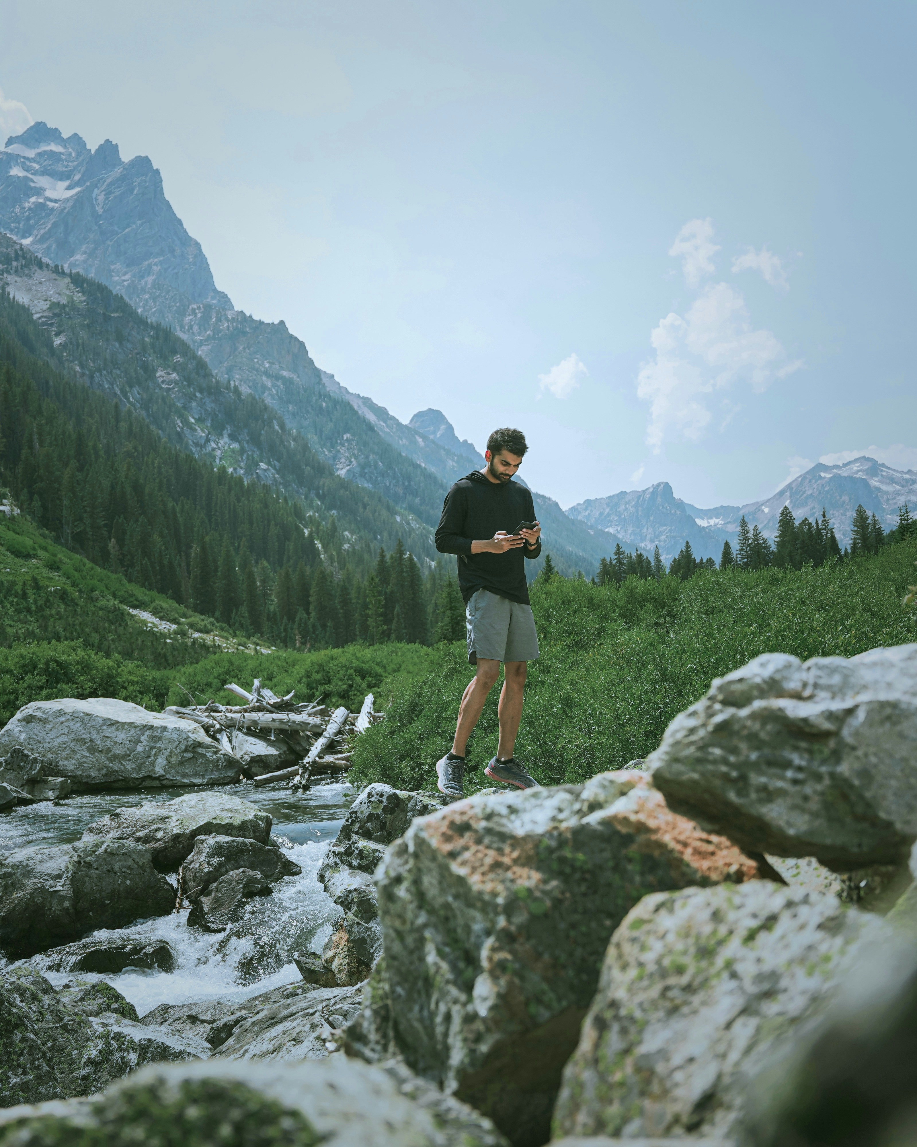 Lone Explorer on Alpine Granite Beneath Towering Peaks