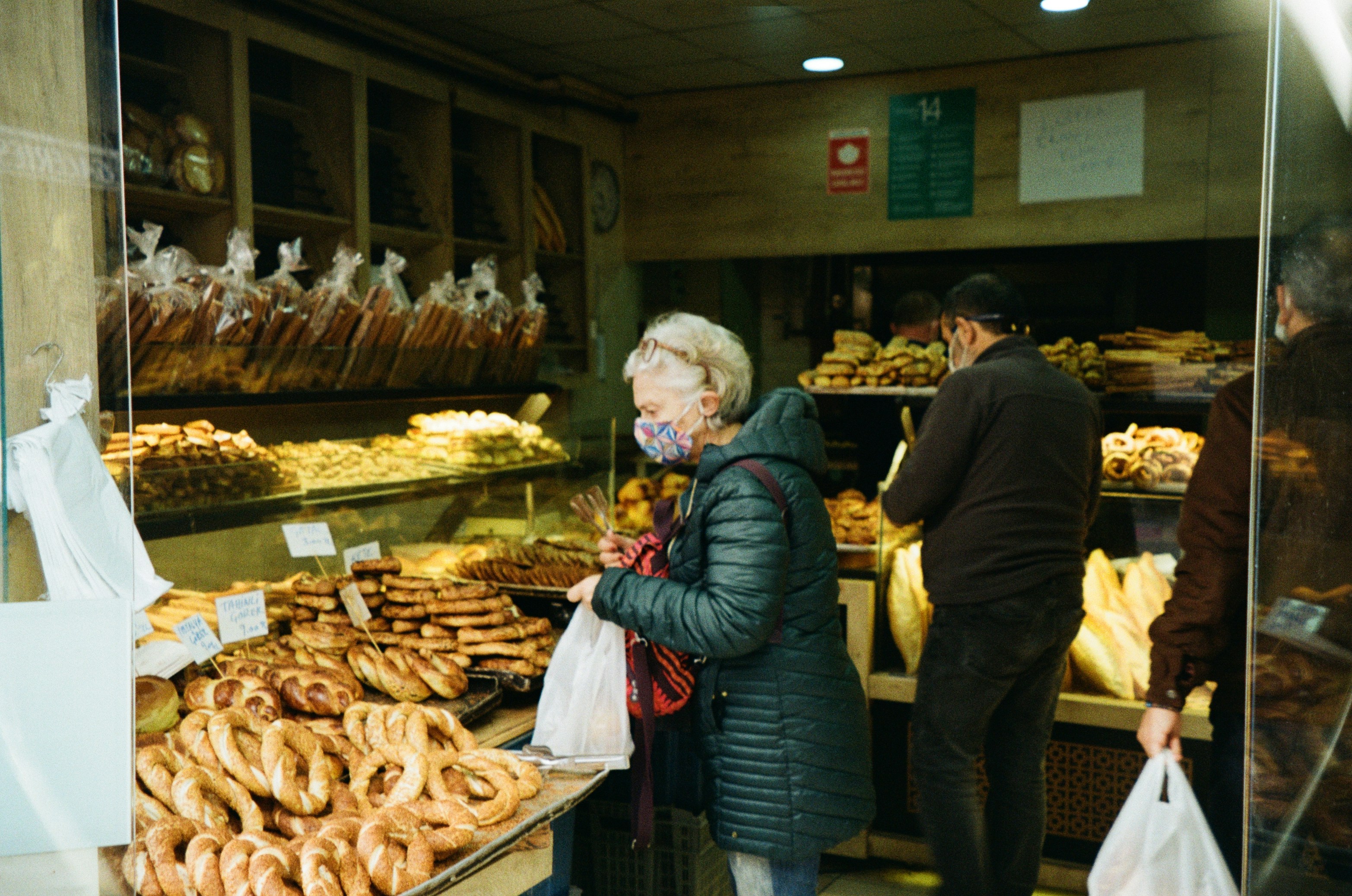 Man in black leather jacket standing beside bread display photo – Free ...