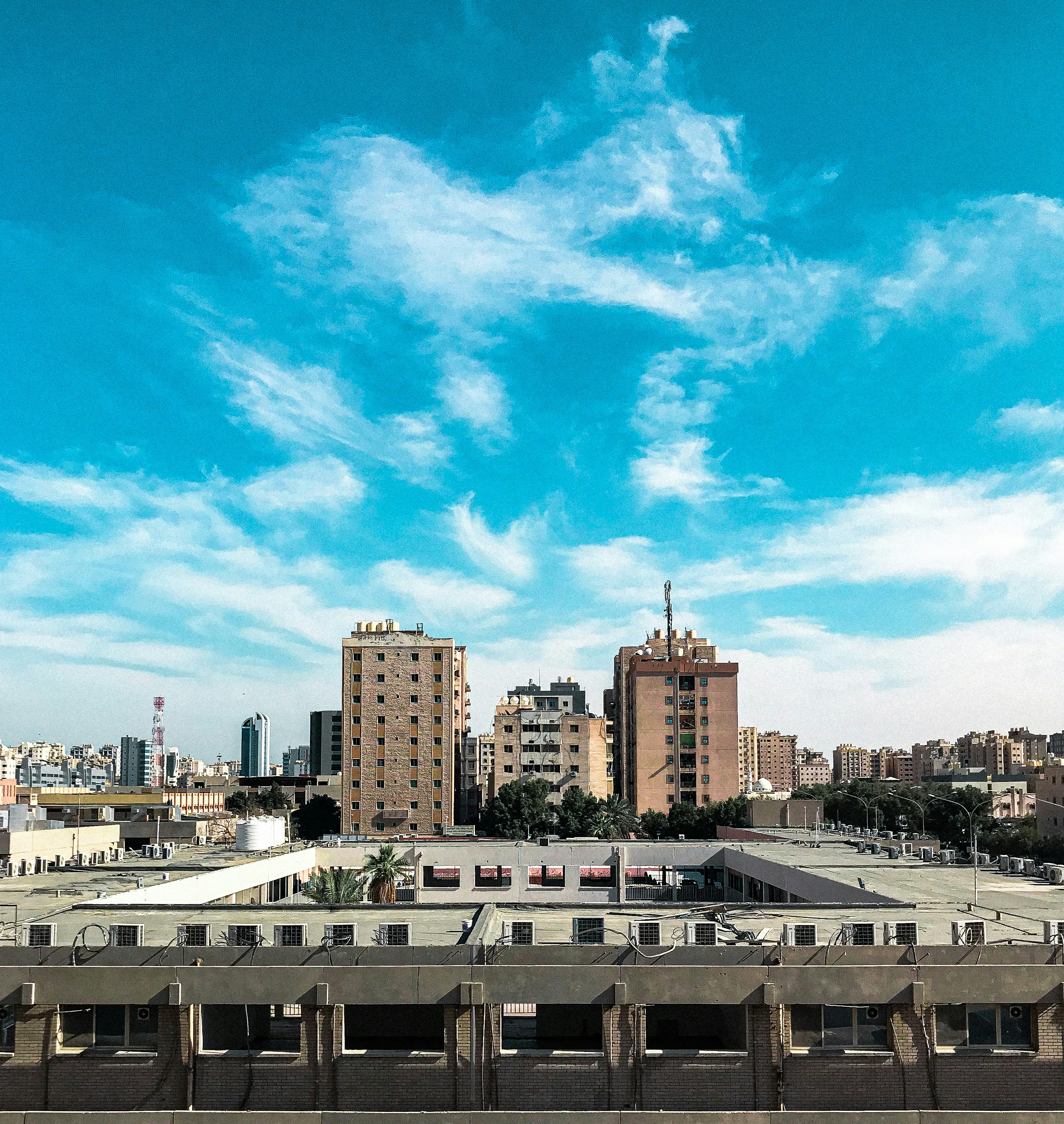 White and brown concrete building under blue sky during daytime photo ...