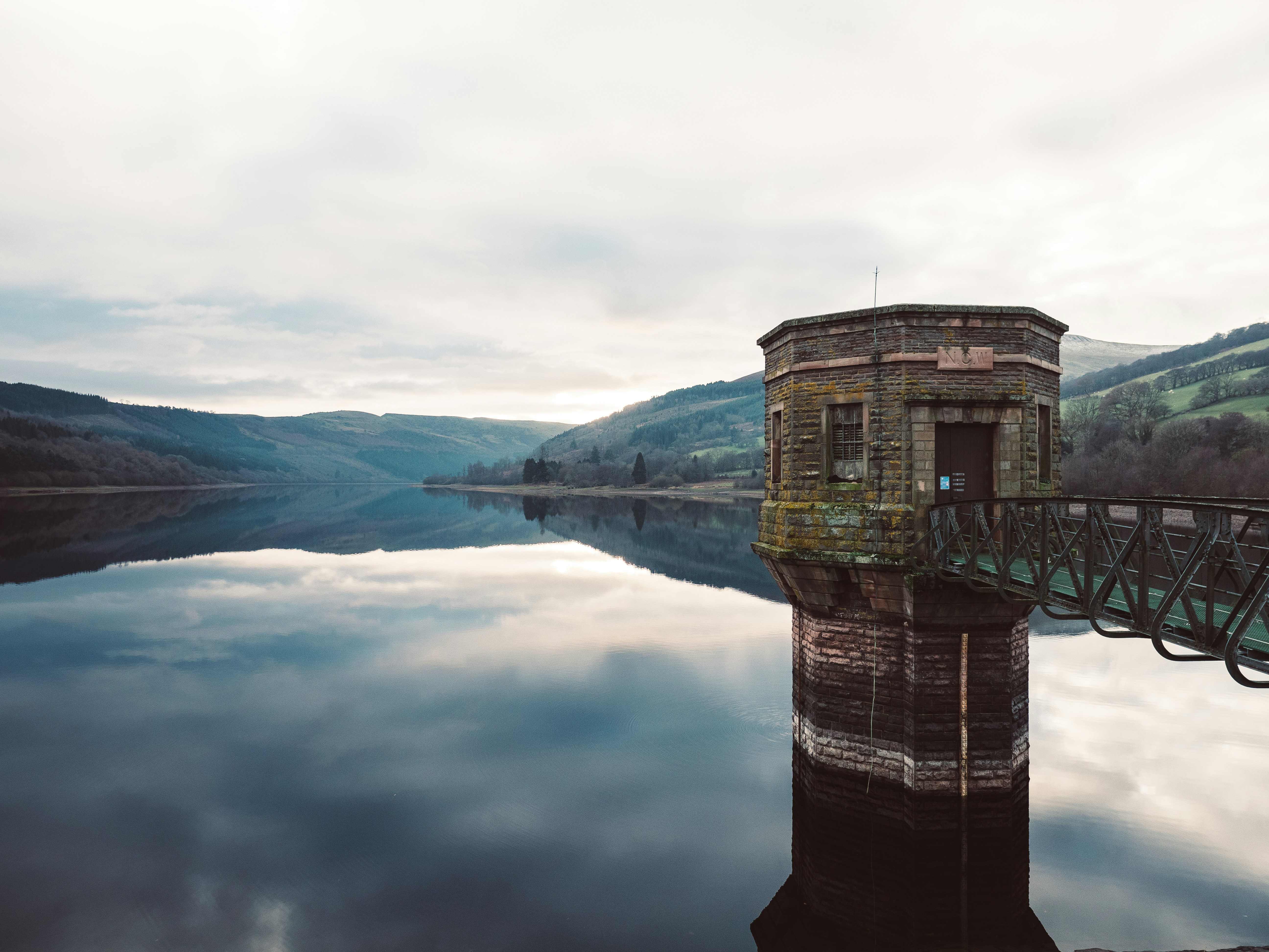 Brown concrete building on lake during daytime photo – Free Brecon ...
