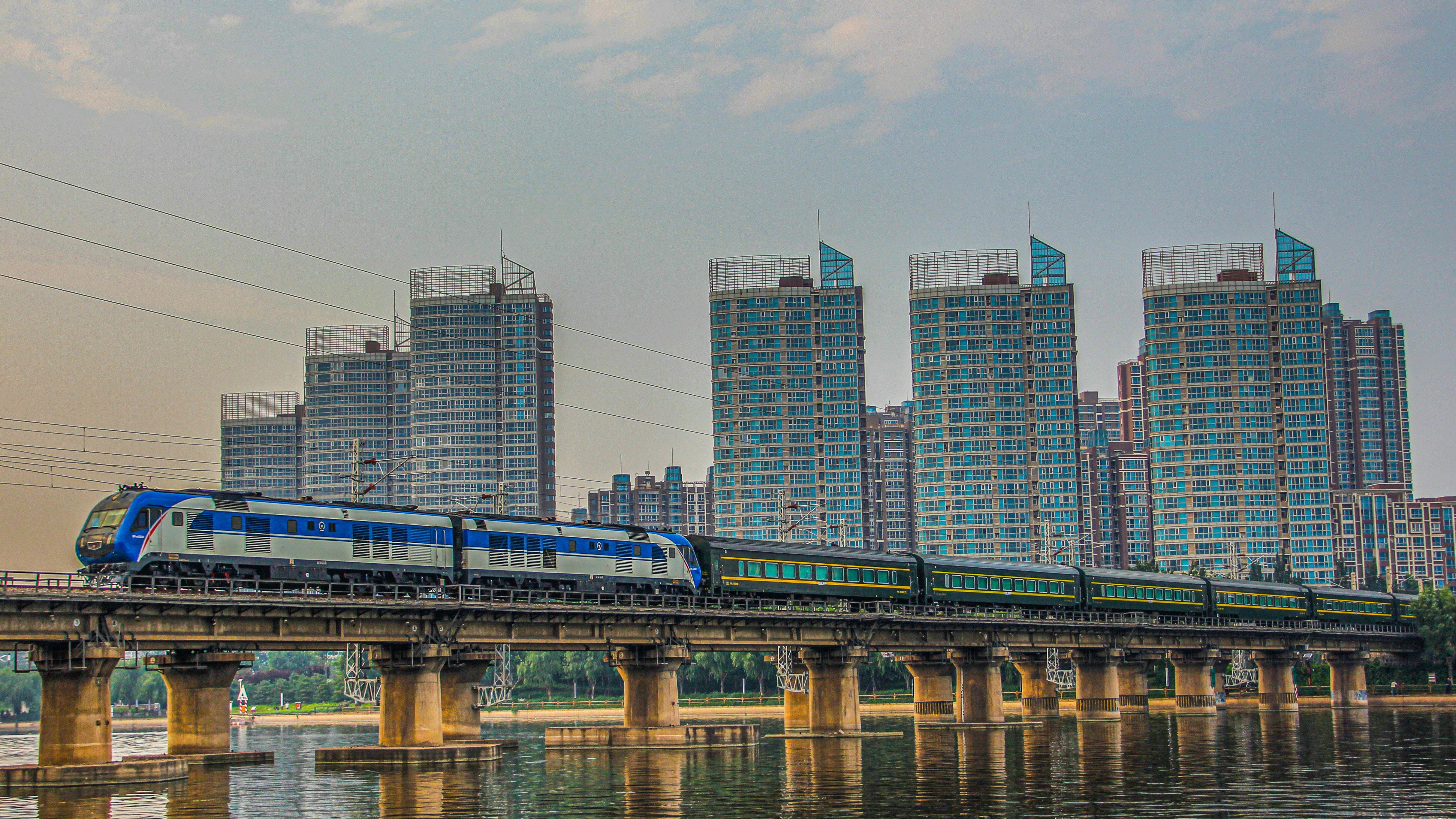 Bridge over river near high rise buildings during daytime photo – Free ...