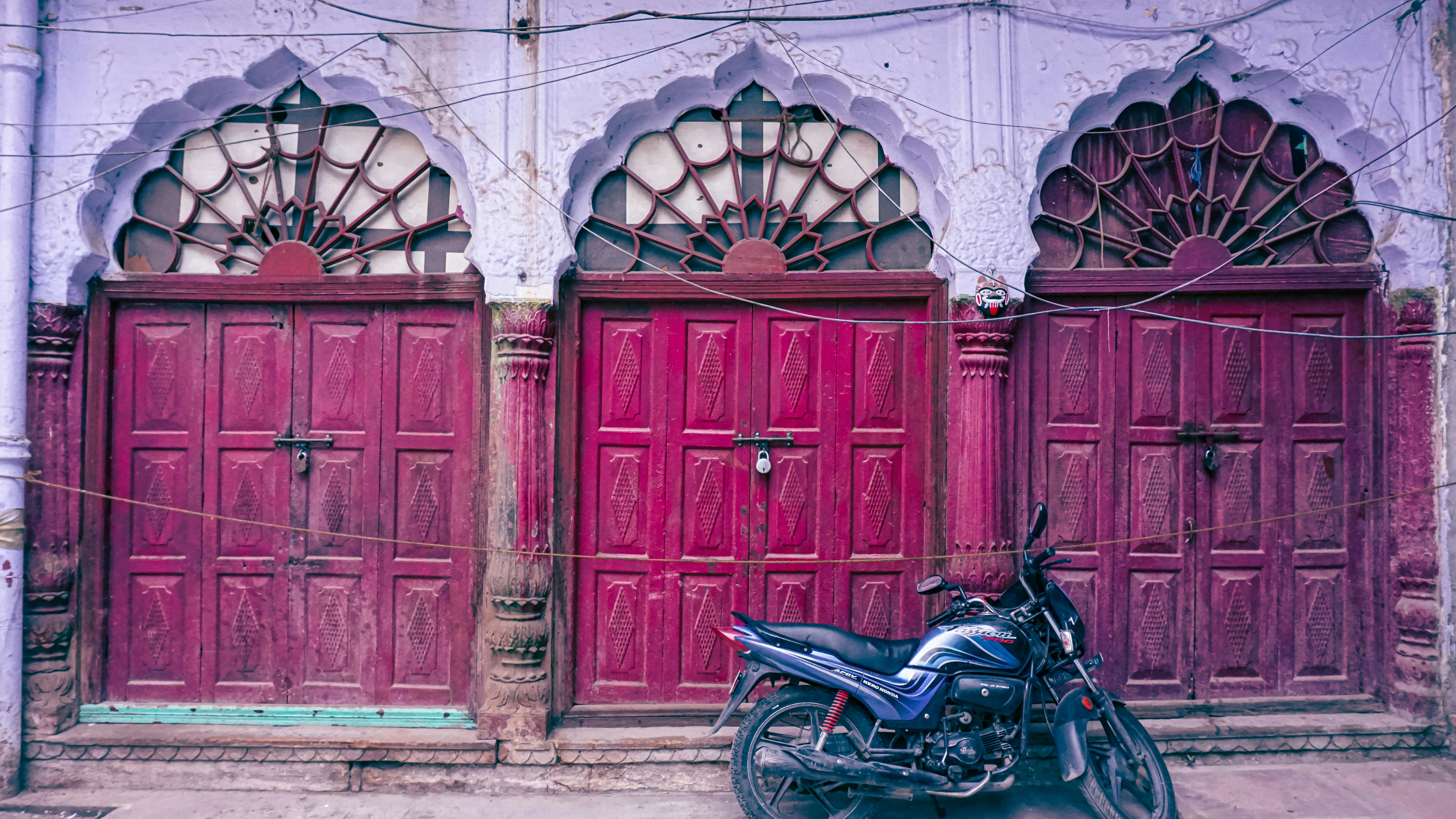 Crimson Facades and a Resting Motorcycle