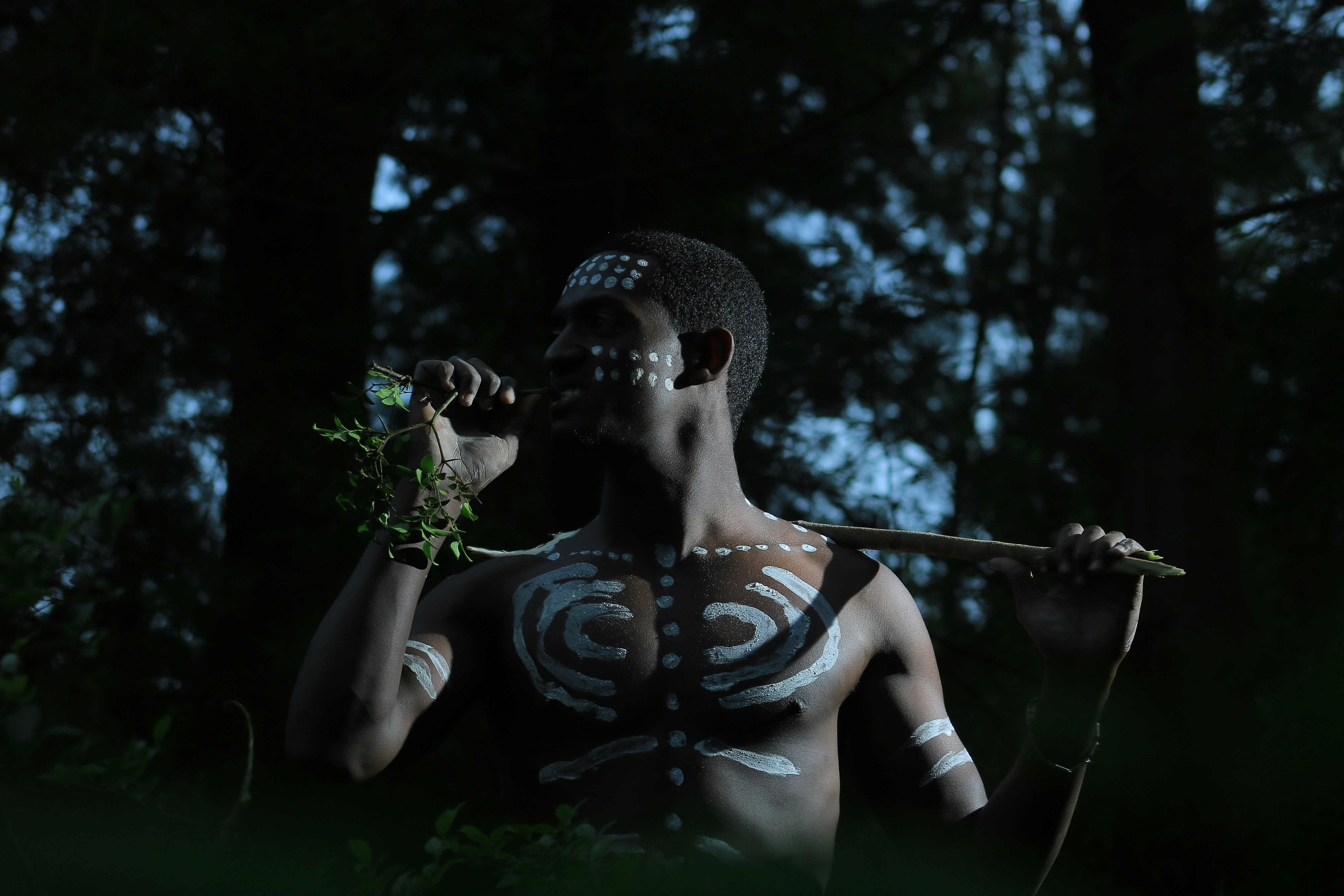Warrior of the Night: Painted Warrior in Shadowed Clearing