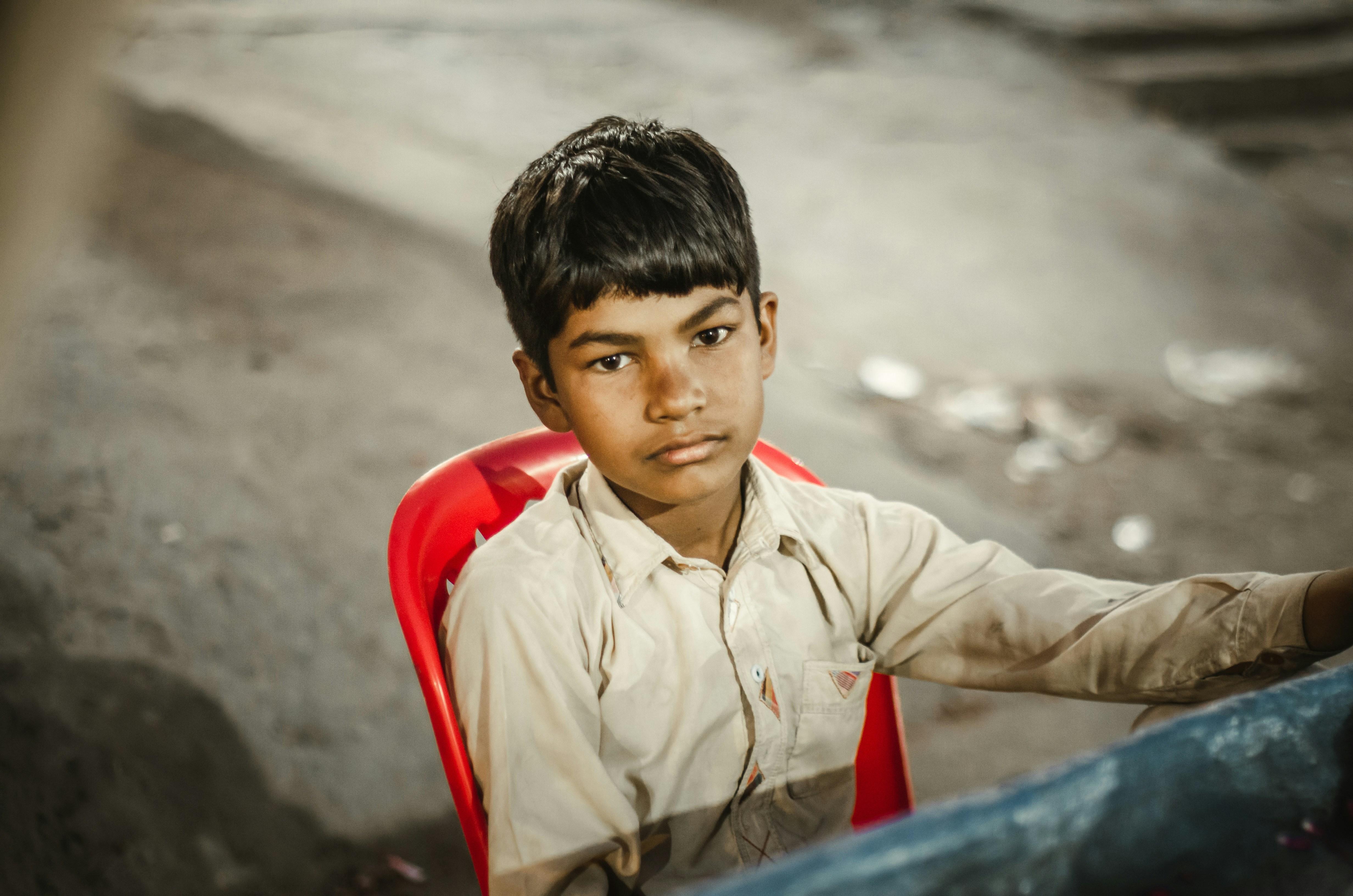 Boy in beige button up shirt sitting on blue metal bench photo – Free ...