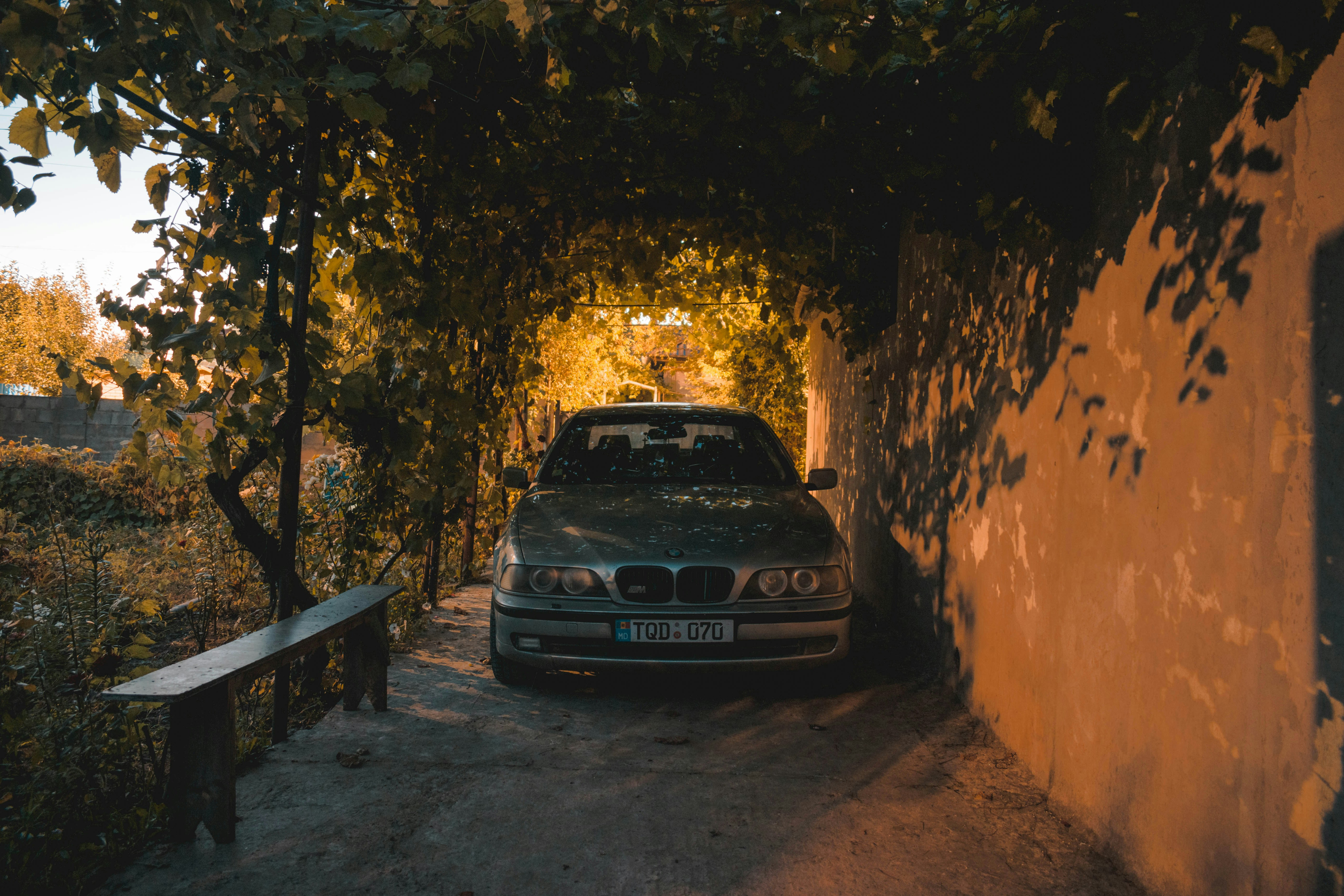 Muted golden hour Car under Arched Corridor