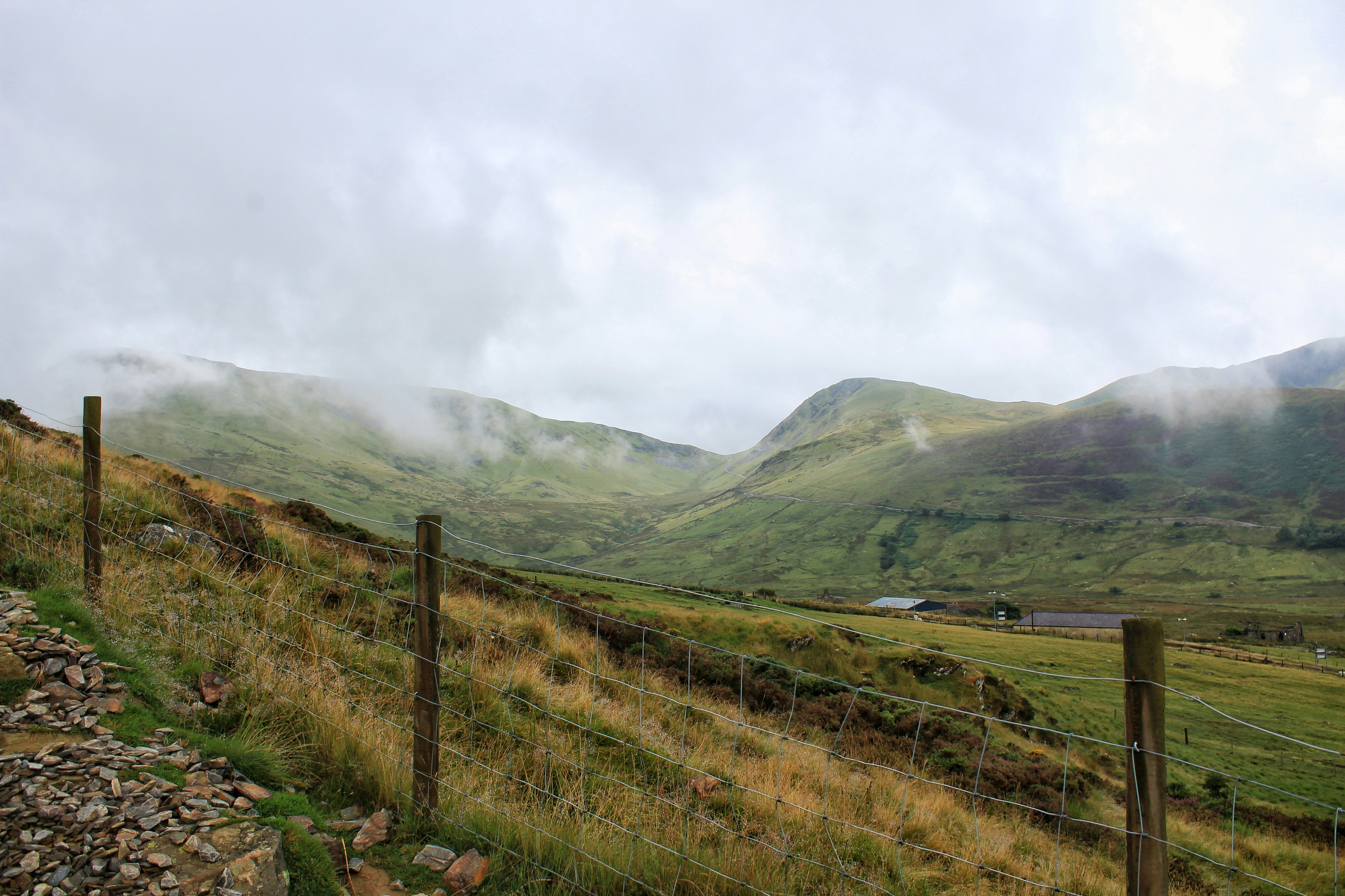 Green grass field near mountain under white clouds during daytime photo ...