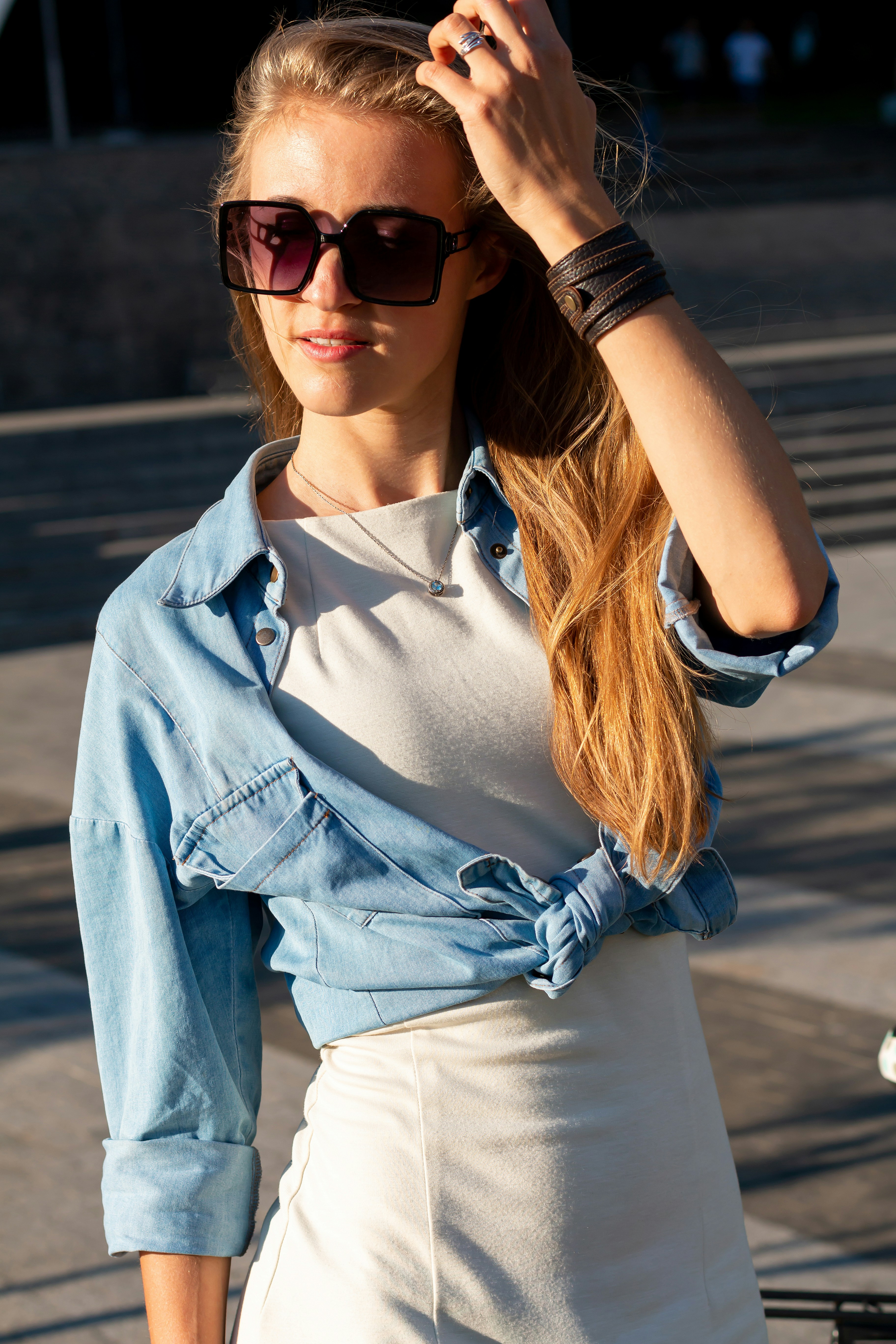Sunlit Denim Confidence: A Bold Portrait in Tie-Front Shirt and Oversized Shades