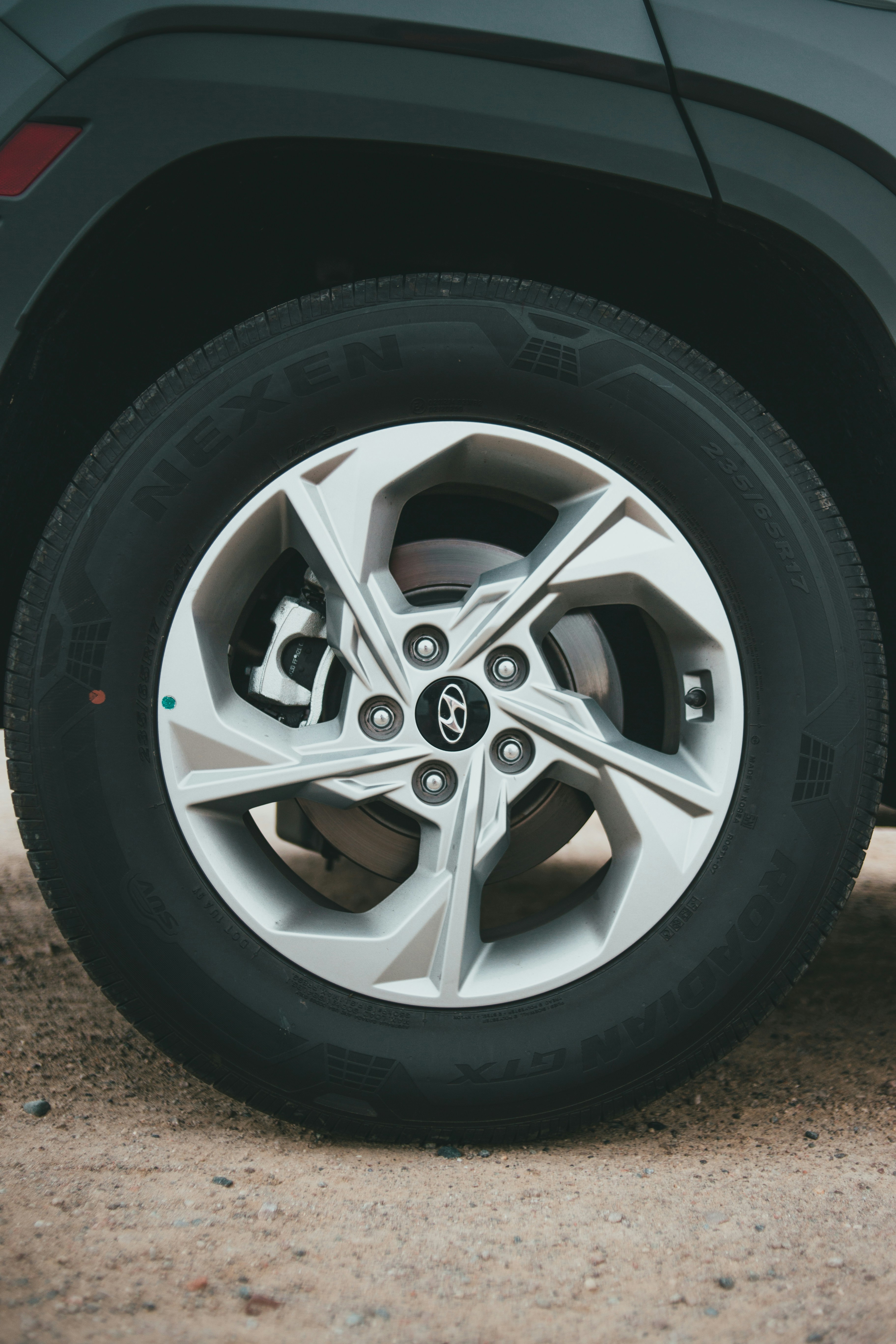 Close-up of a Hyundai wheel featuring a sleek alloy design and Nexen tire, highlighting automotive craftsmanship.